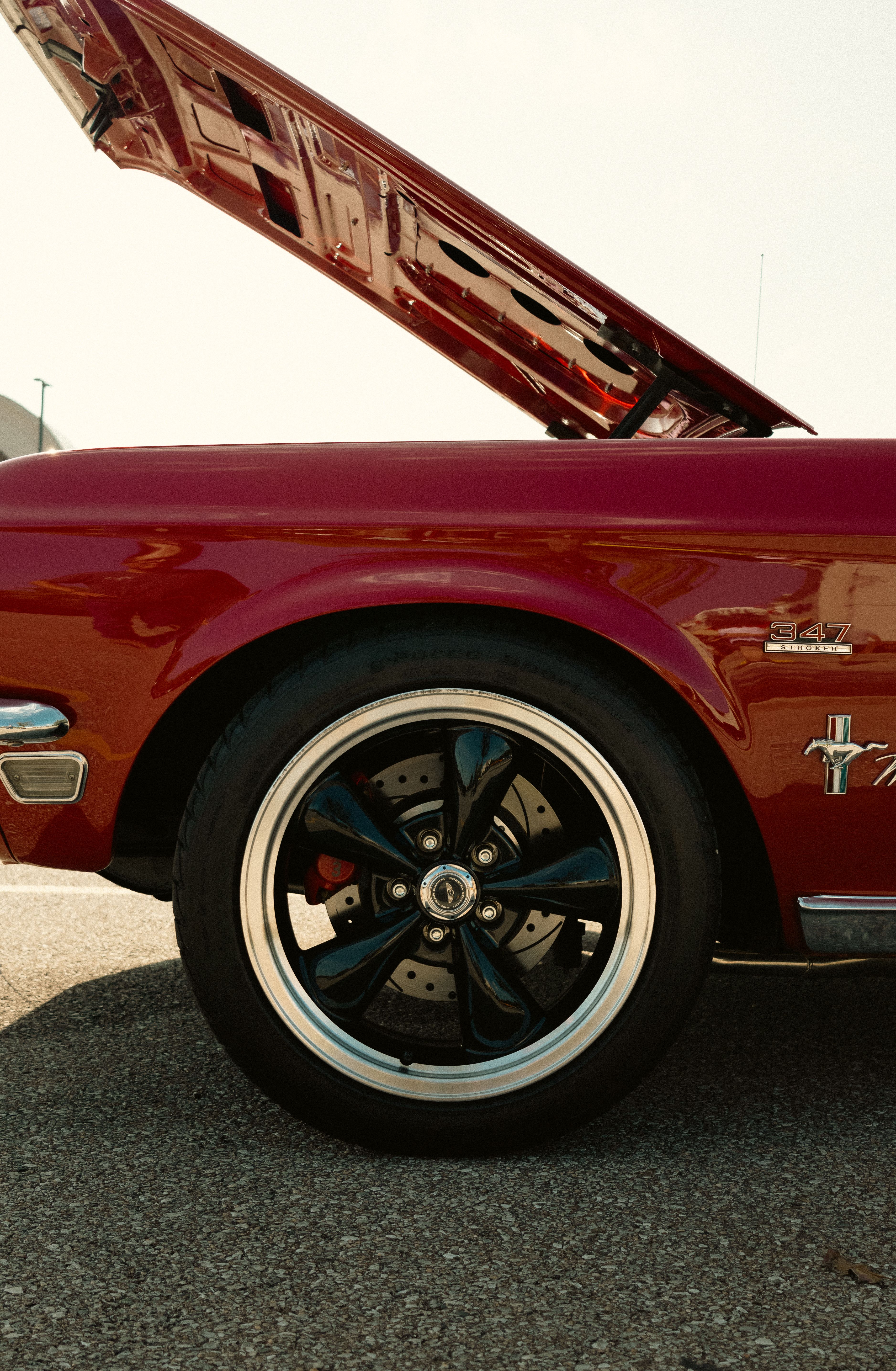 A red mustang with its hood open · Free Stock Photo