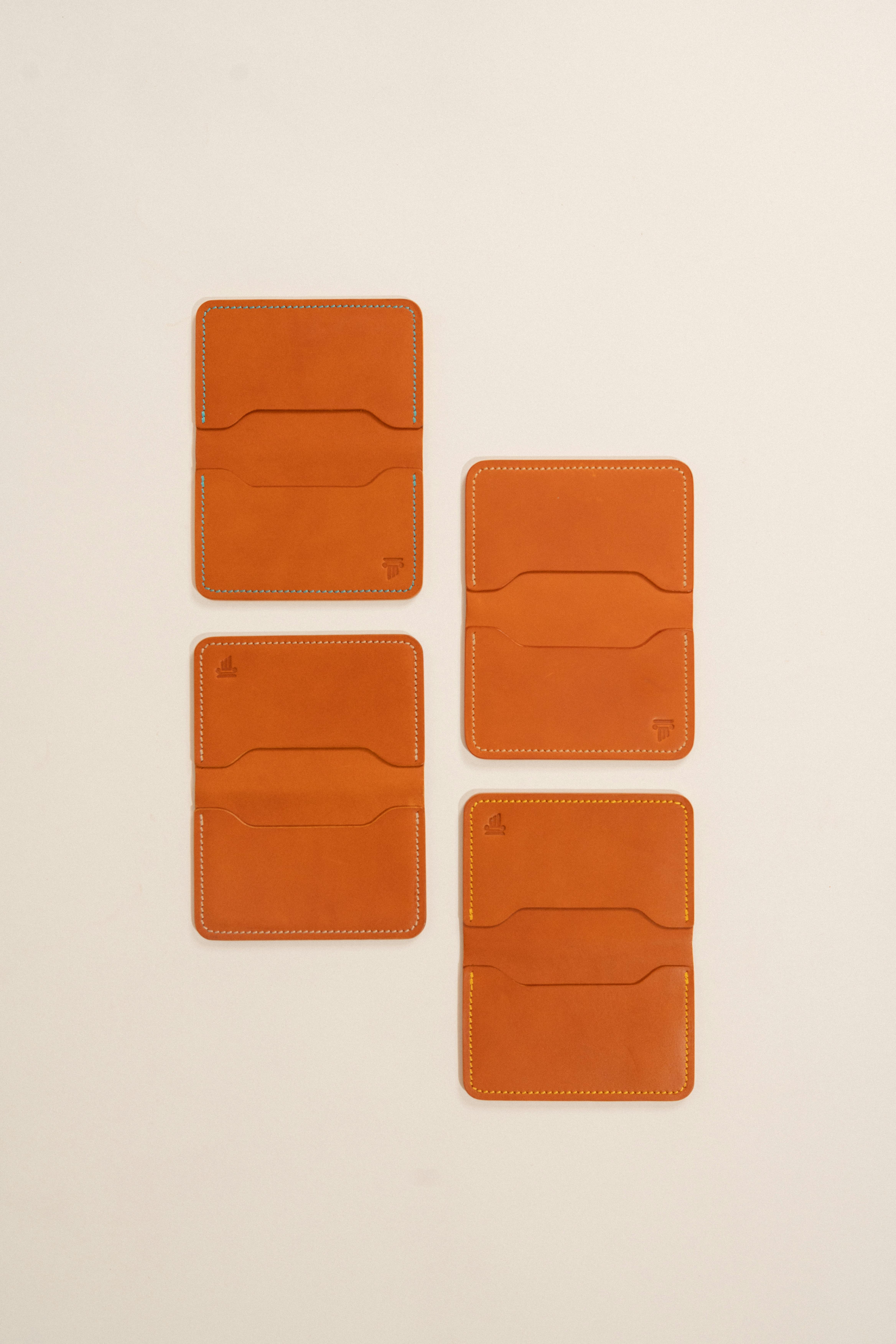 Four orange leather cards with four different designs · Free Stock Photo