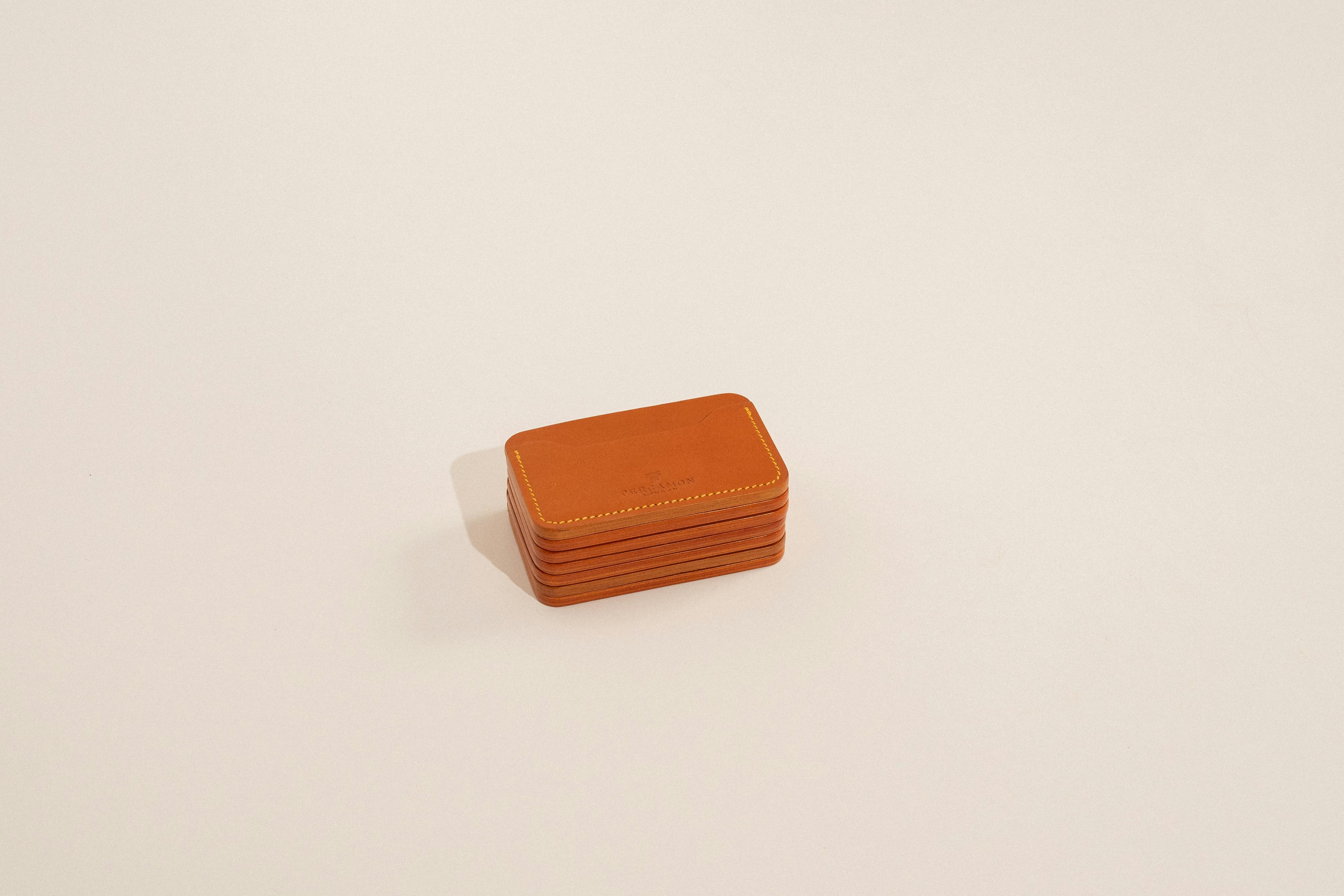 A small orange box on a white surface · Free Stock Photo