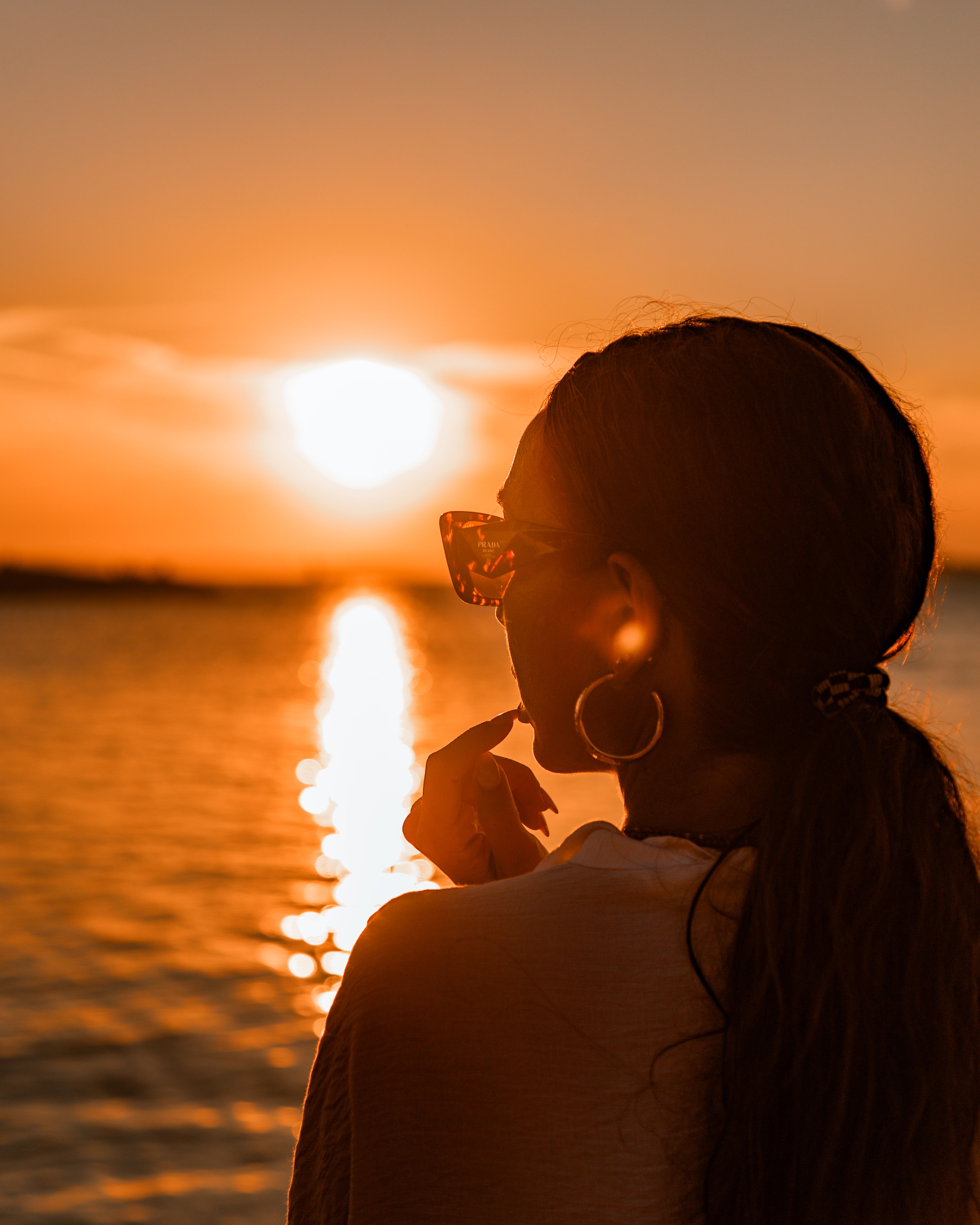 A woman looking at the sunset from the water · Free Stock Photo