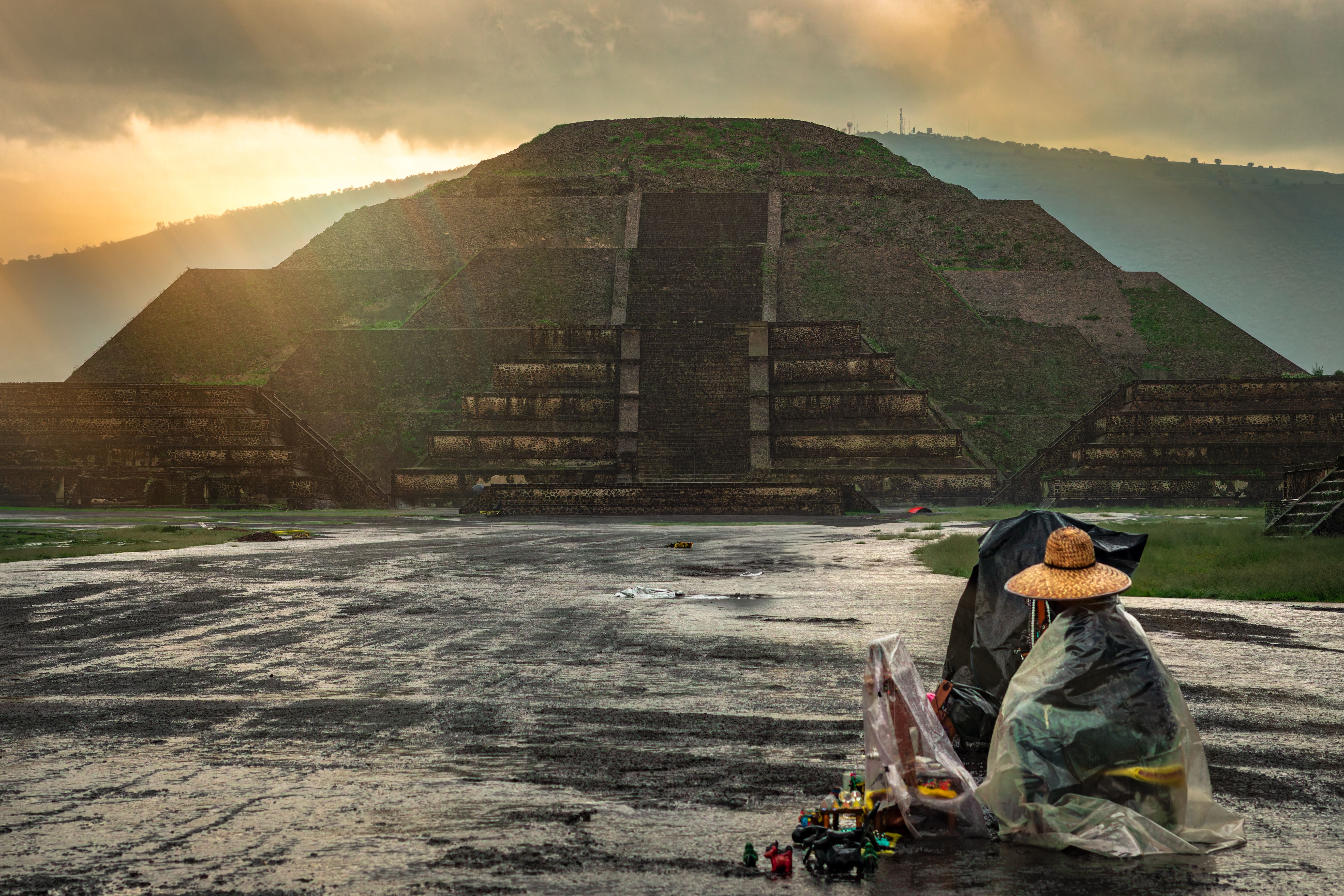 A man sitting on the ground in front of an ancient pyramid · Free Stock ...