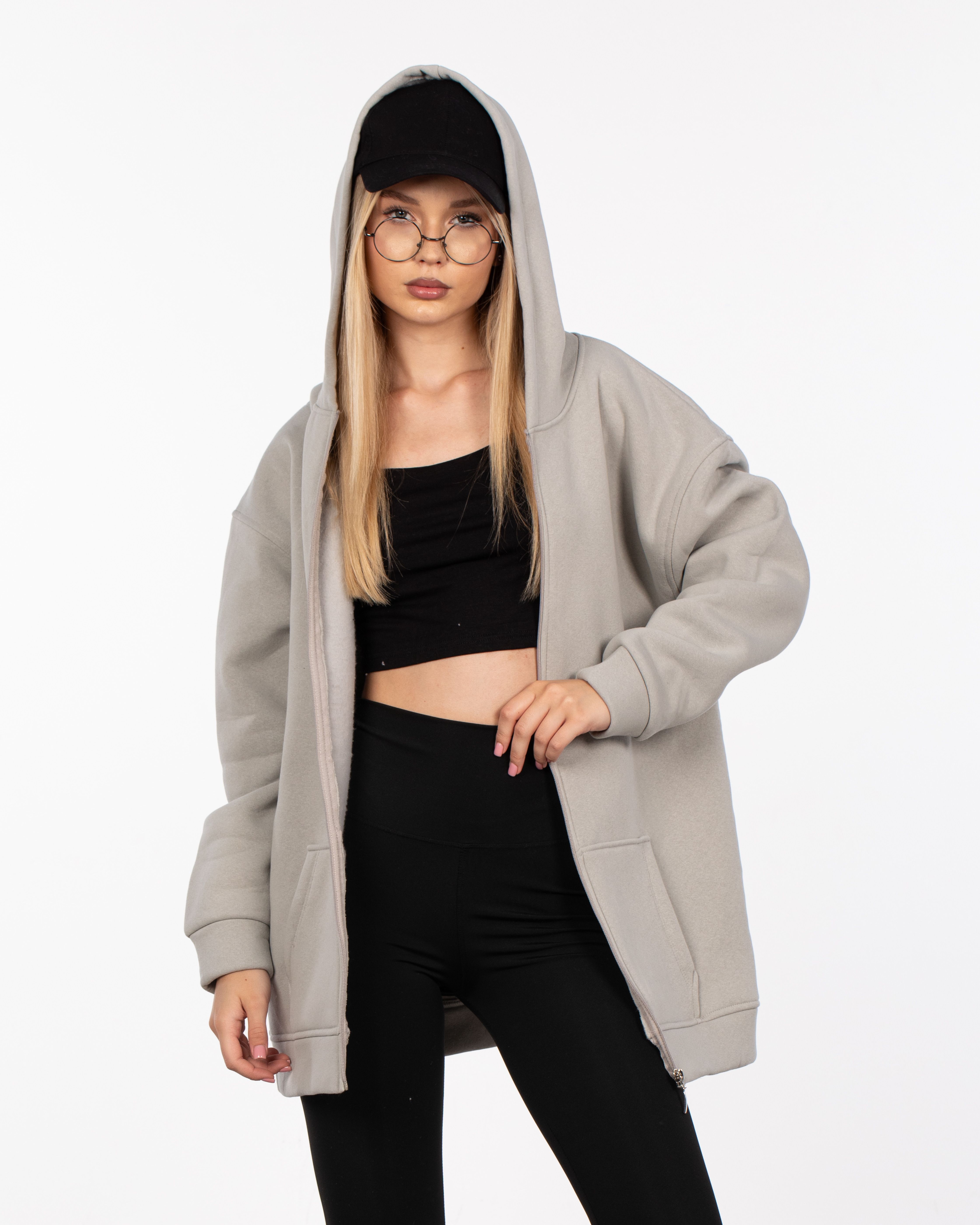 The model is wearing a grey hoodie and black leggings · Free Stock Photo