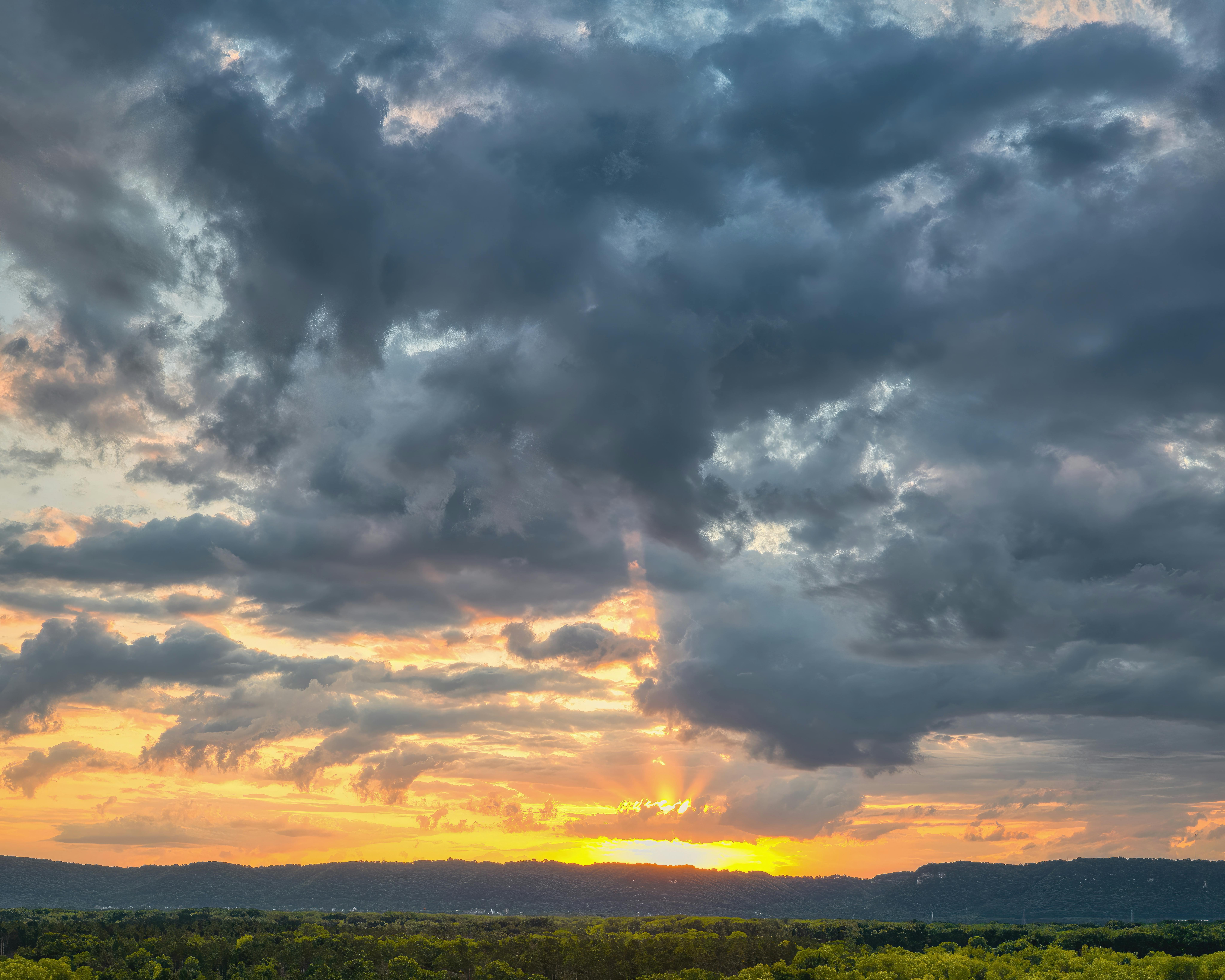 Sunset over the plains with clouds and trees · Free Stock Photo