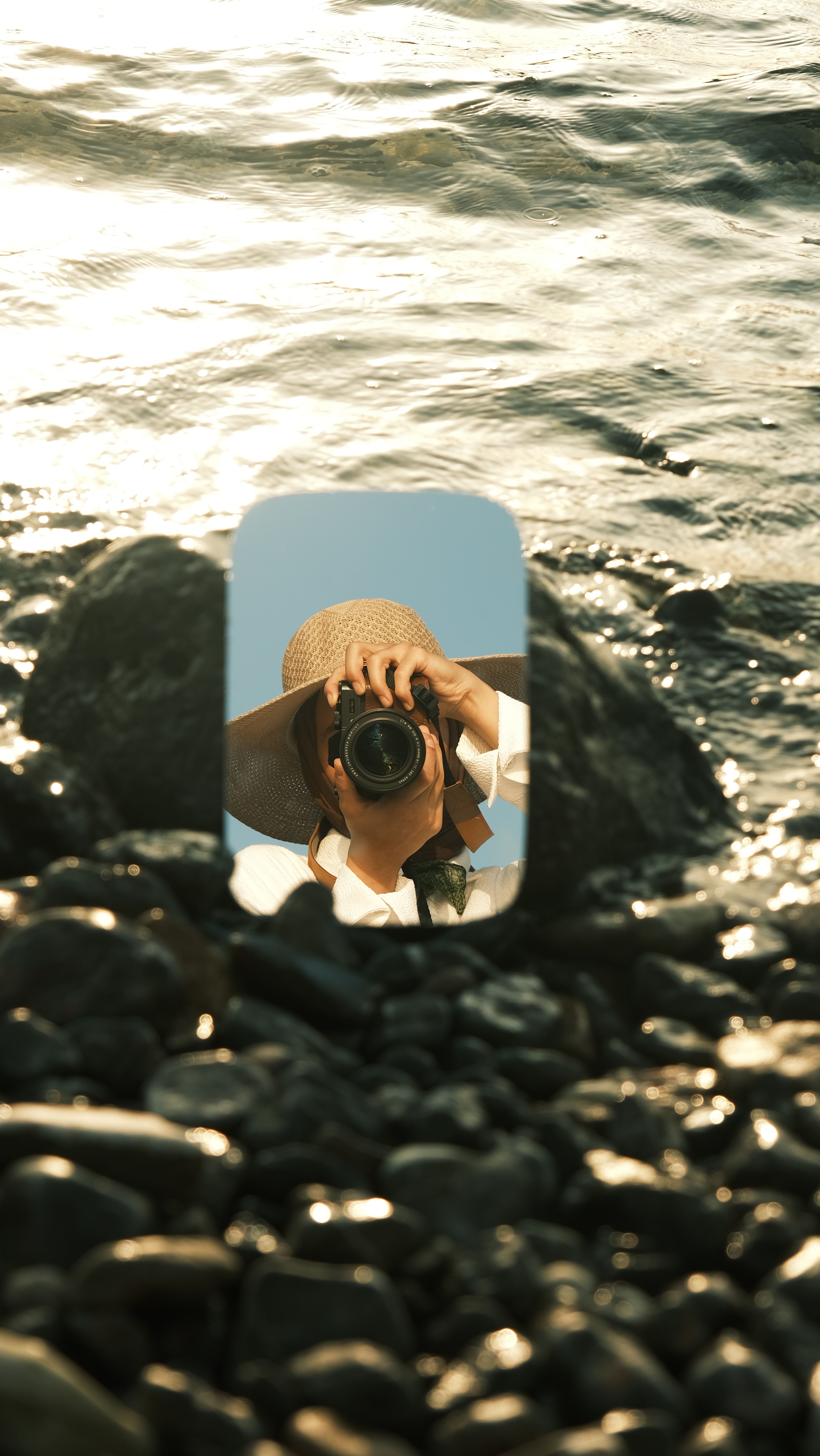 A person taking a photo of the ocean with a camera · Free Stock Photo