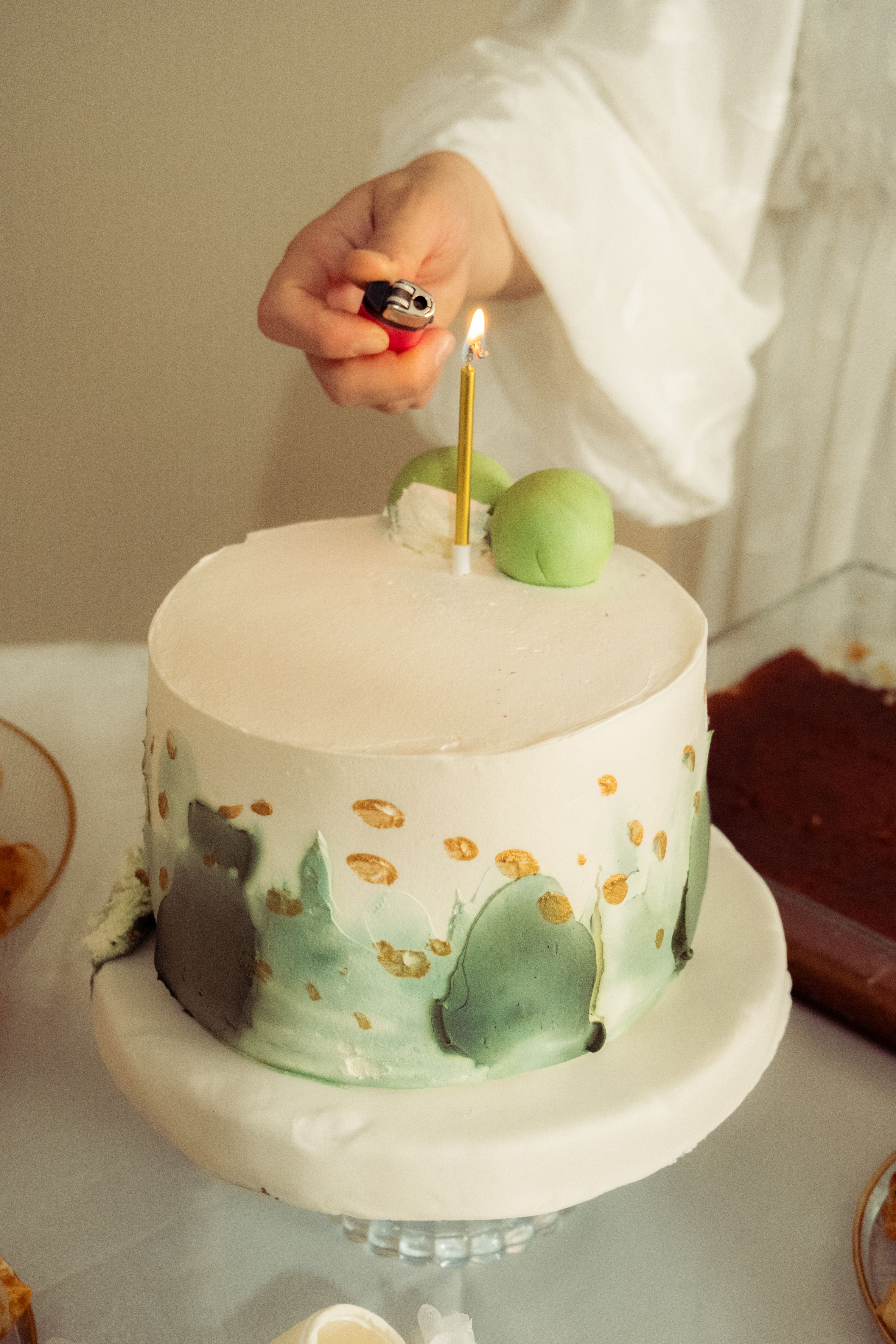 Woman Lighting Up a Wedding Cake · Free Stock Photo