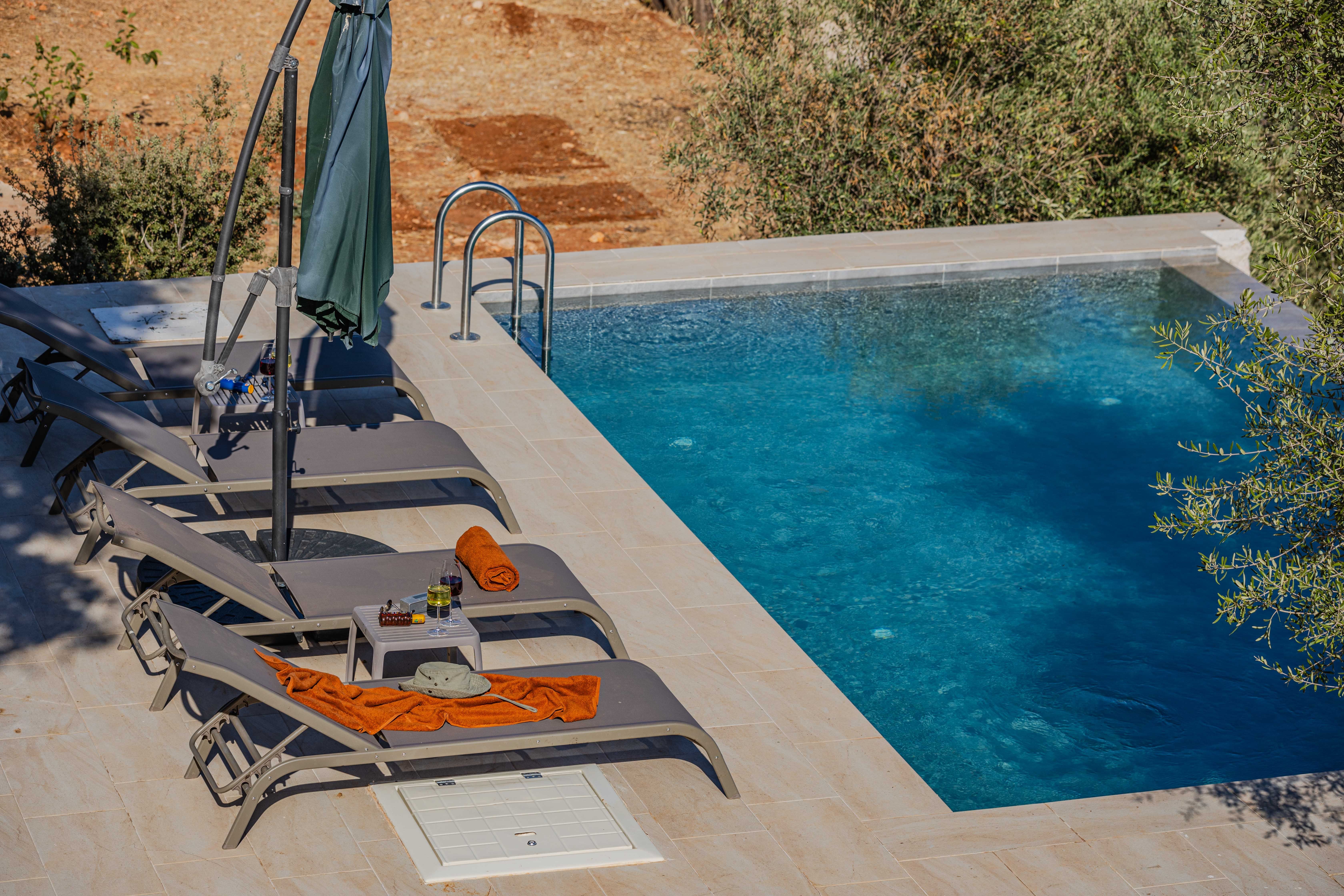 Red Outdoor Lounge Chairs Near Swimming Pool · Free Stock Photo