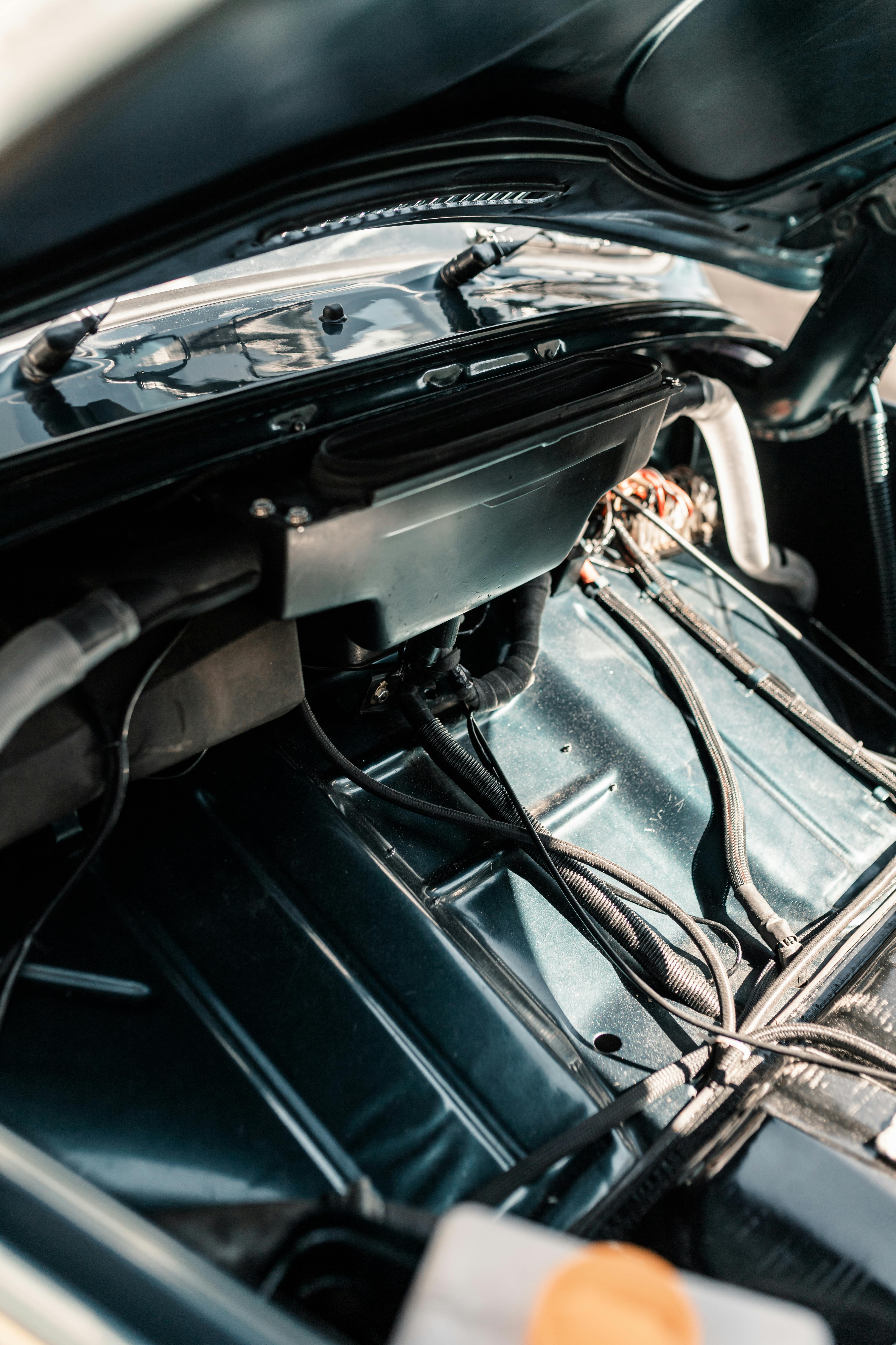 The inside of a car with the engine compartment open · Free Stock Photo