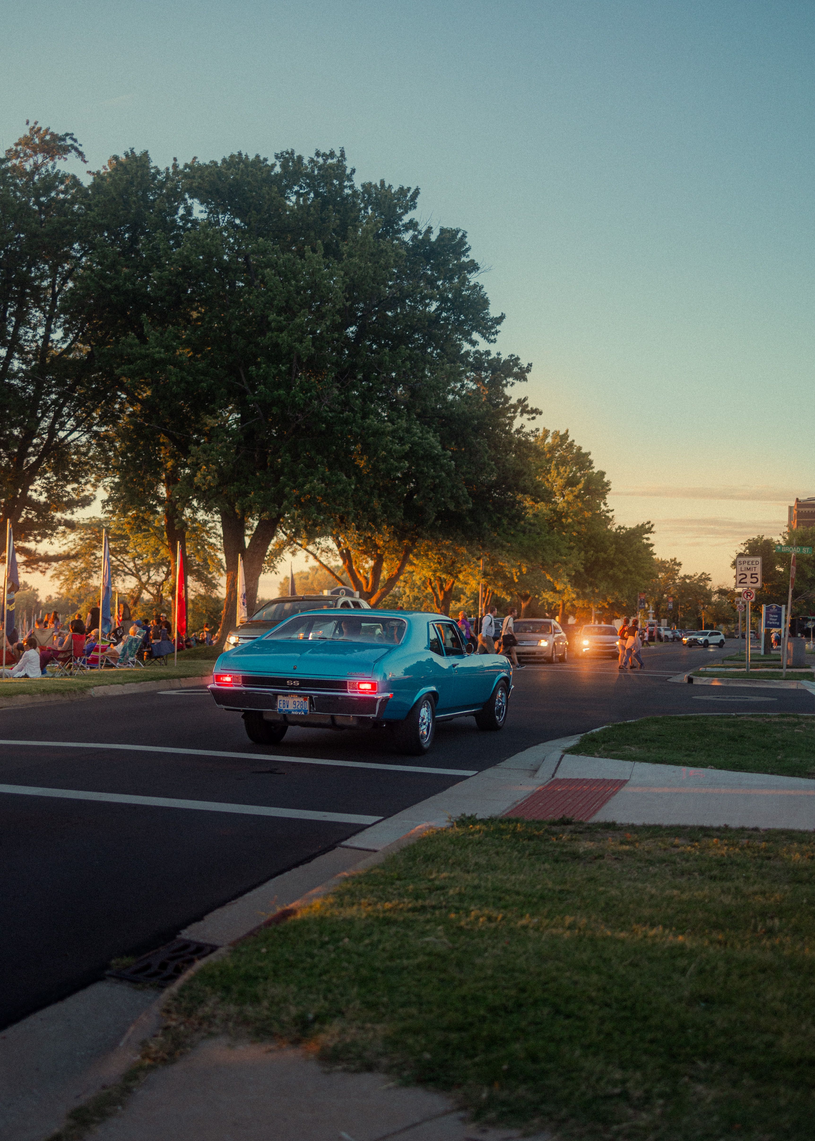 A car driving down a street at dusk · Free Stock Photo
