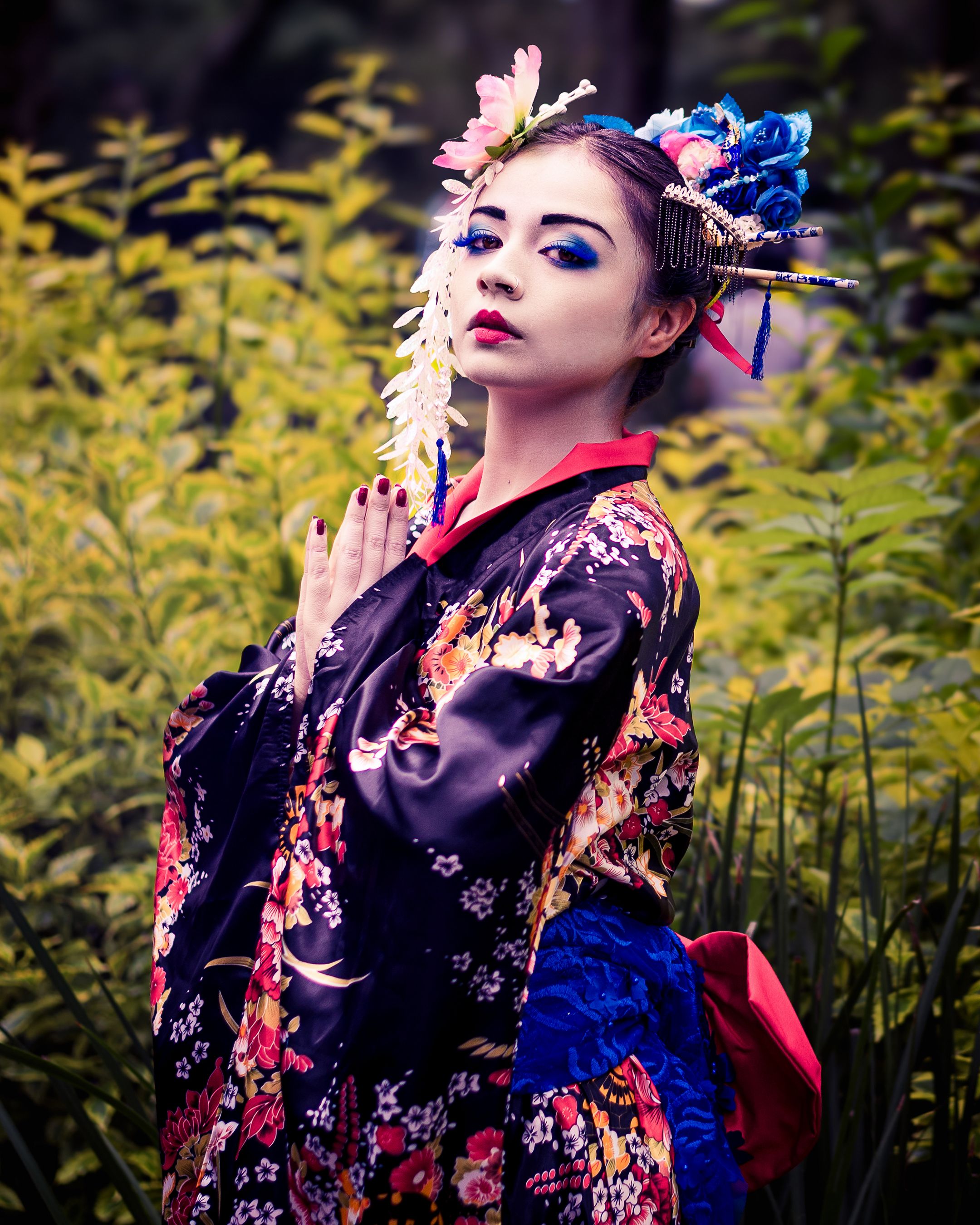 A woman in a geisha costume poses in the woods · Free Stock Photo