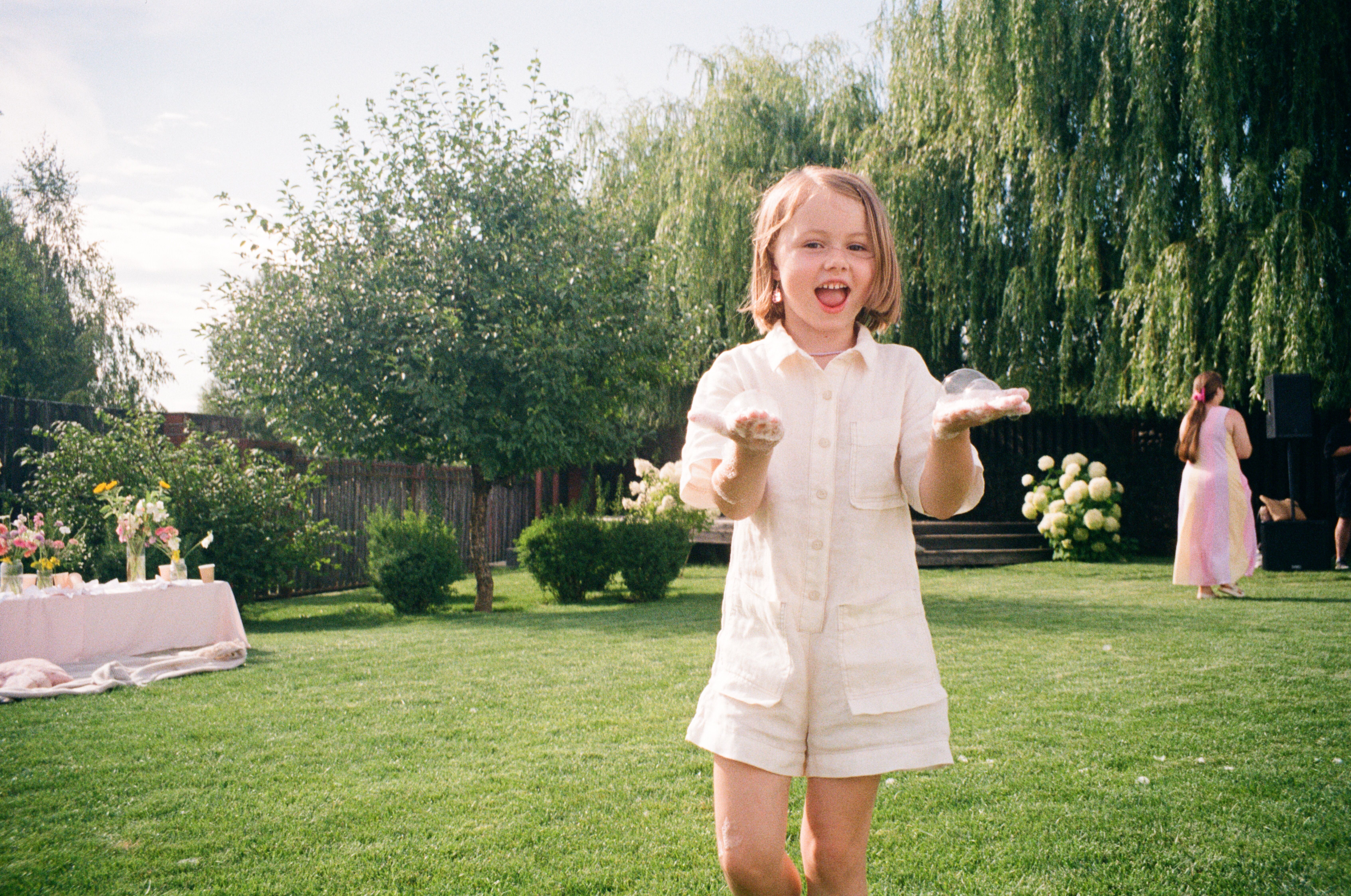 Joyful Child Playing Outdoors in Sunny Garden · Free Stock Photo