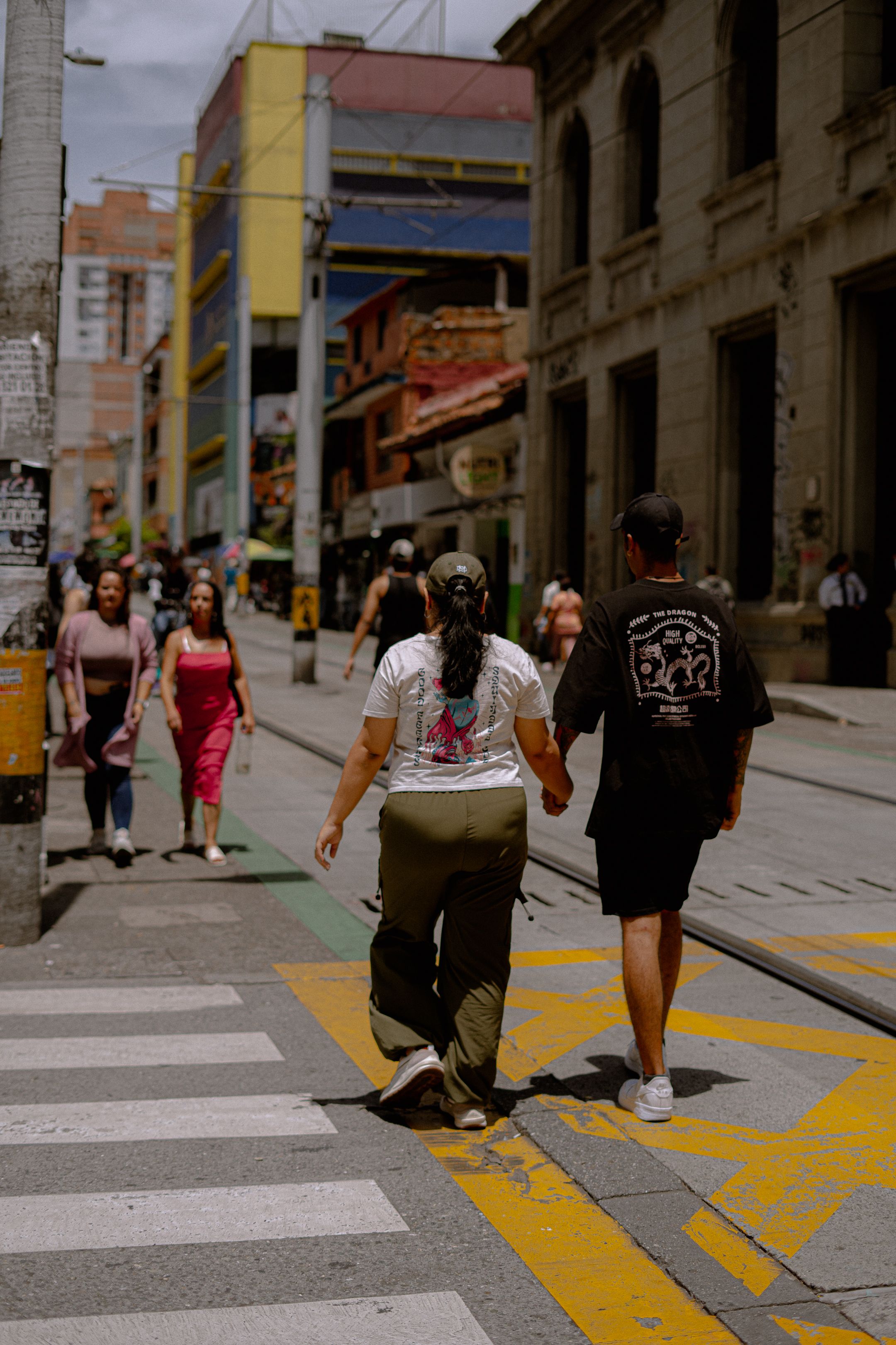 Two people walking across a street in a city · Free Stock Photo