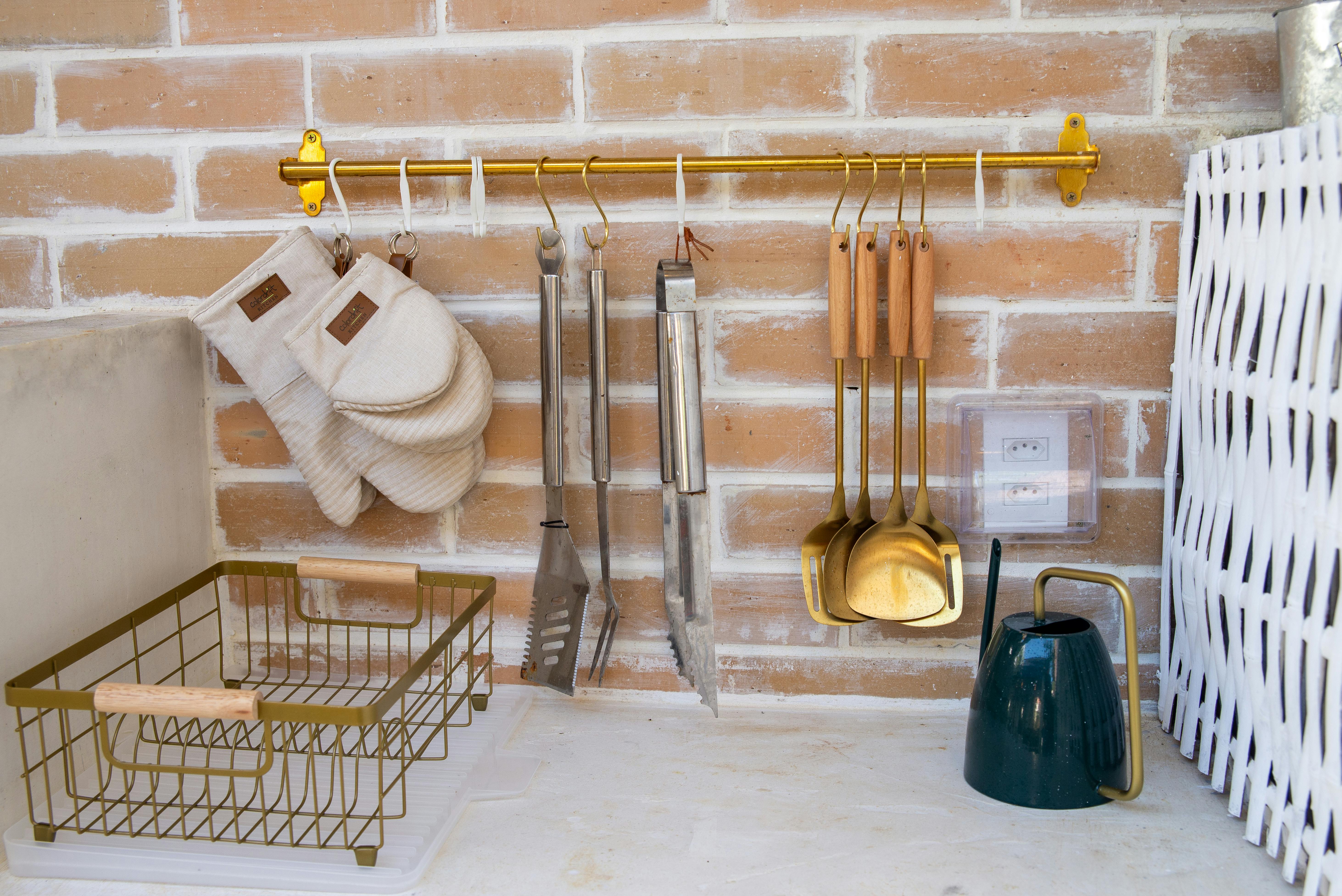 A kitchen with a gold metal rack and utensils · Free Stock Photo