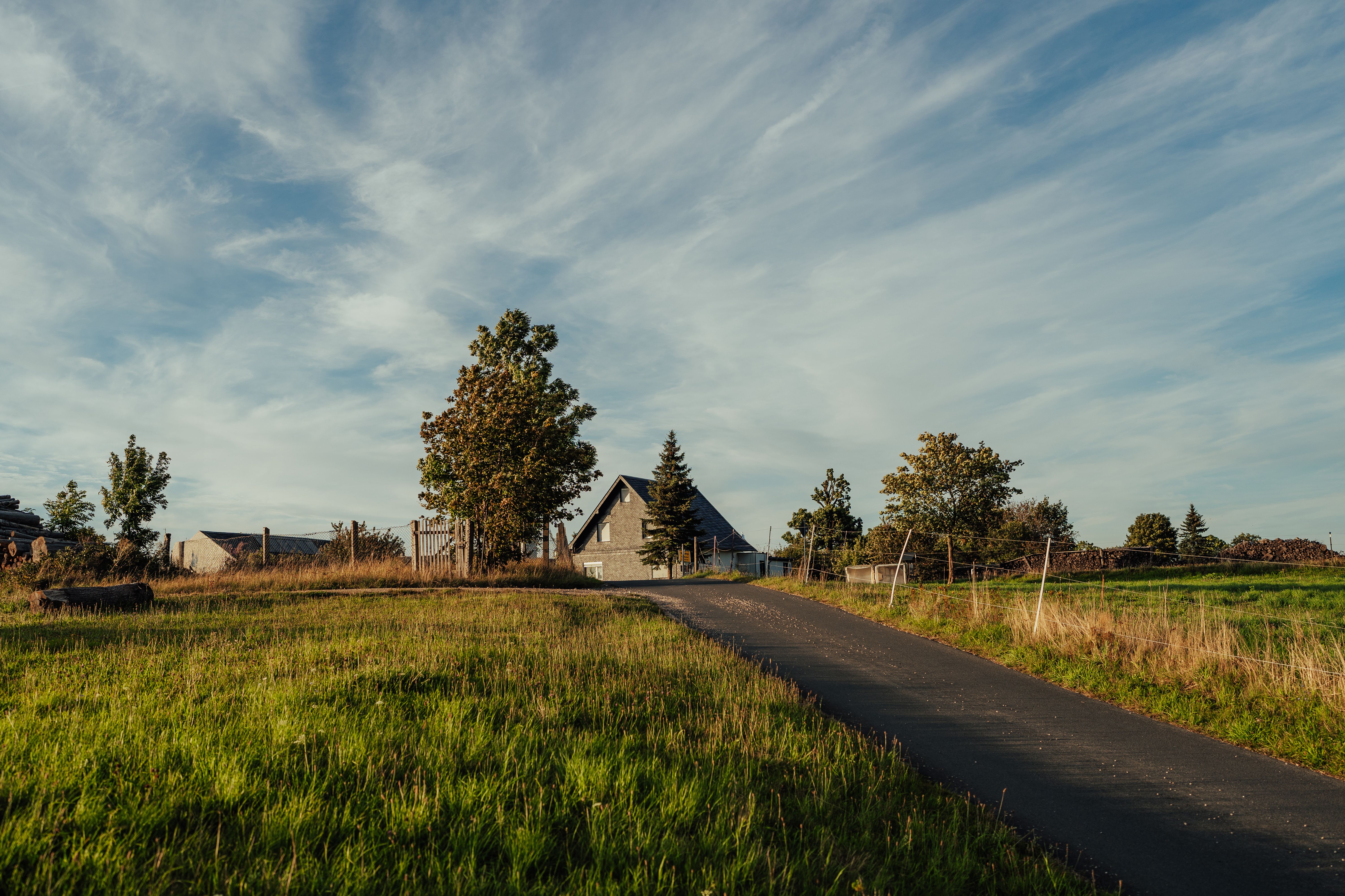 A road with a church in the distance · Free Stock Photo