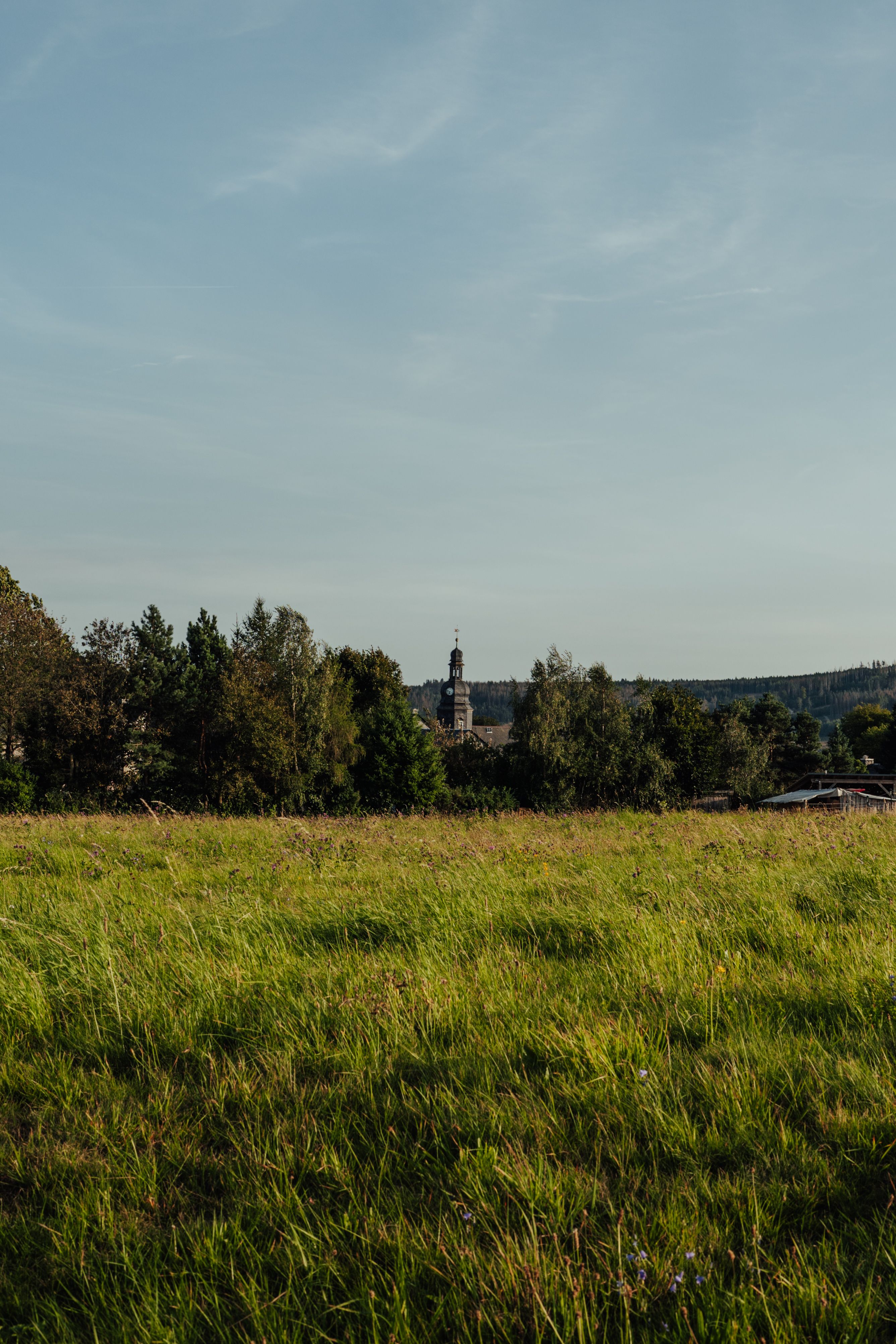 A field with a church in the background · Free Stock Photo