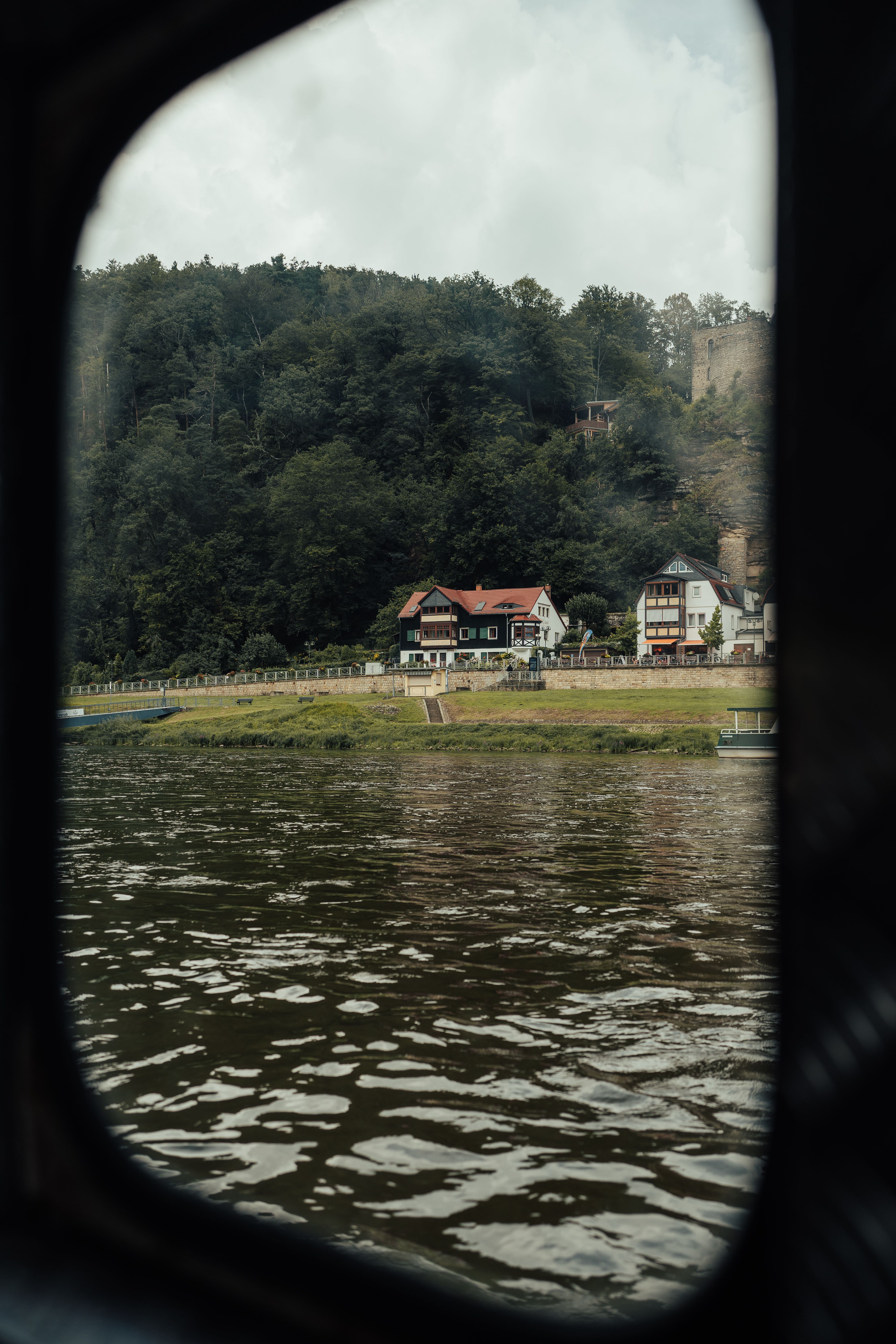 A view of a river and houses through a window · Free Stock Photo