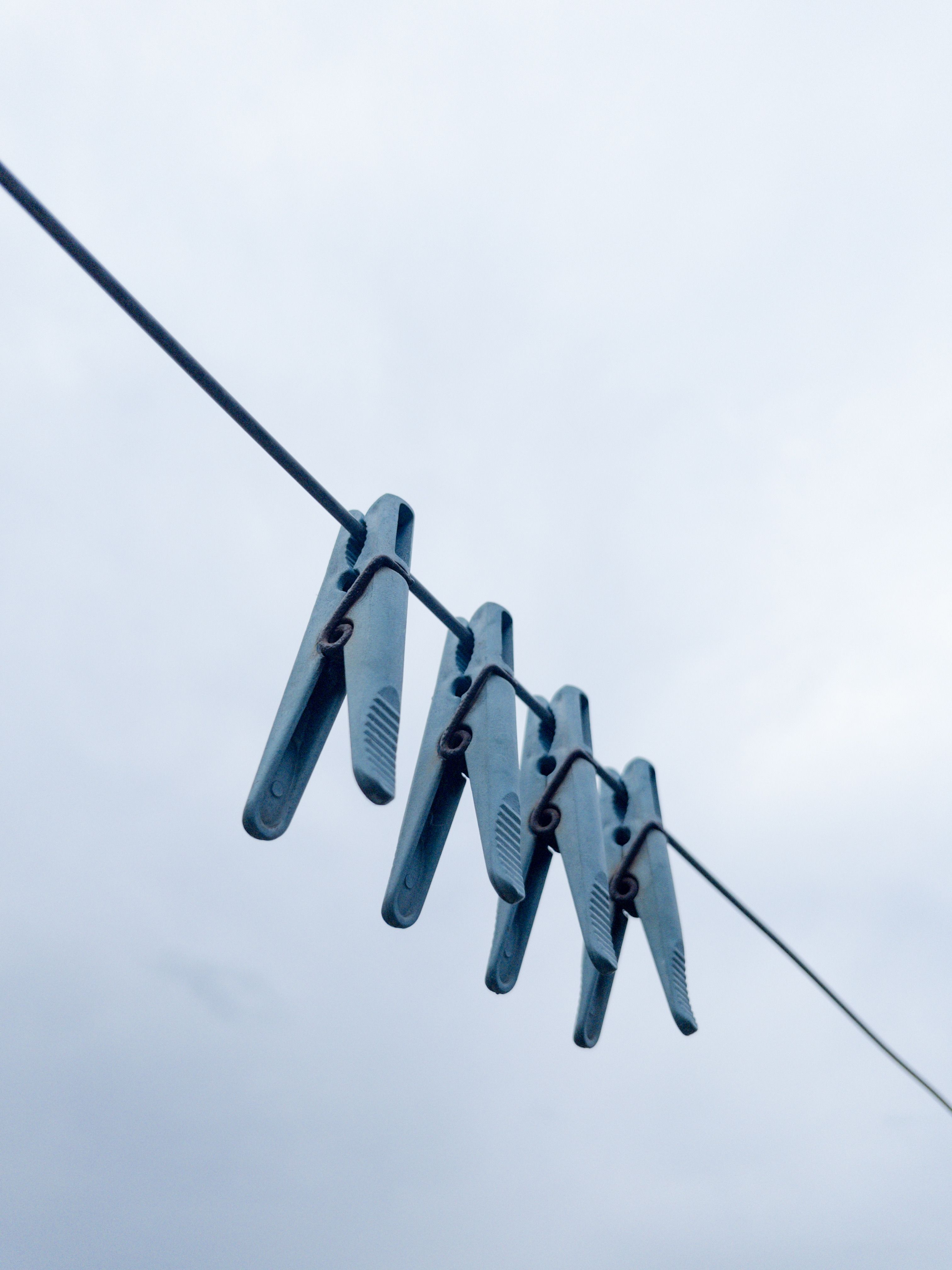 Clothes pegs hanging on a clothes line · Free Stock Photo