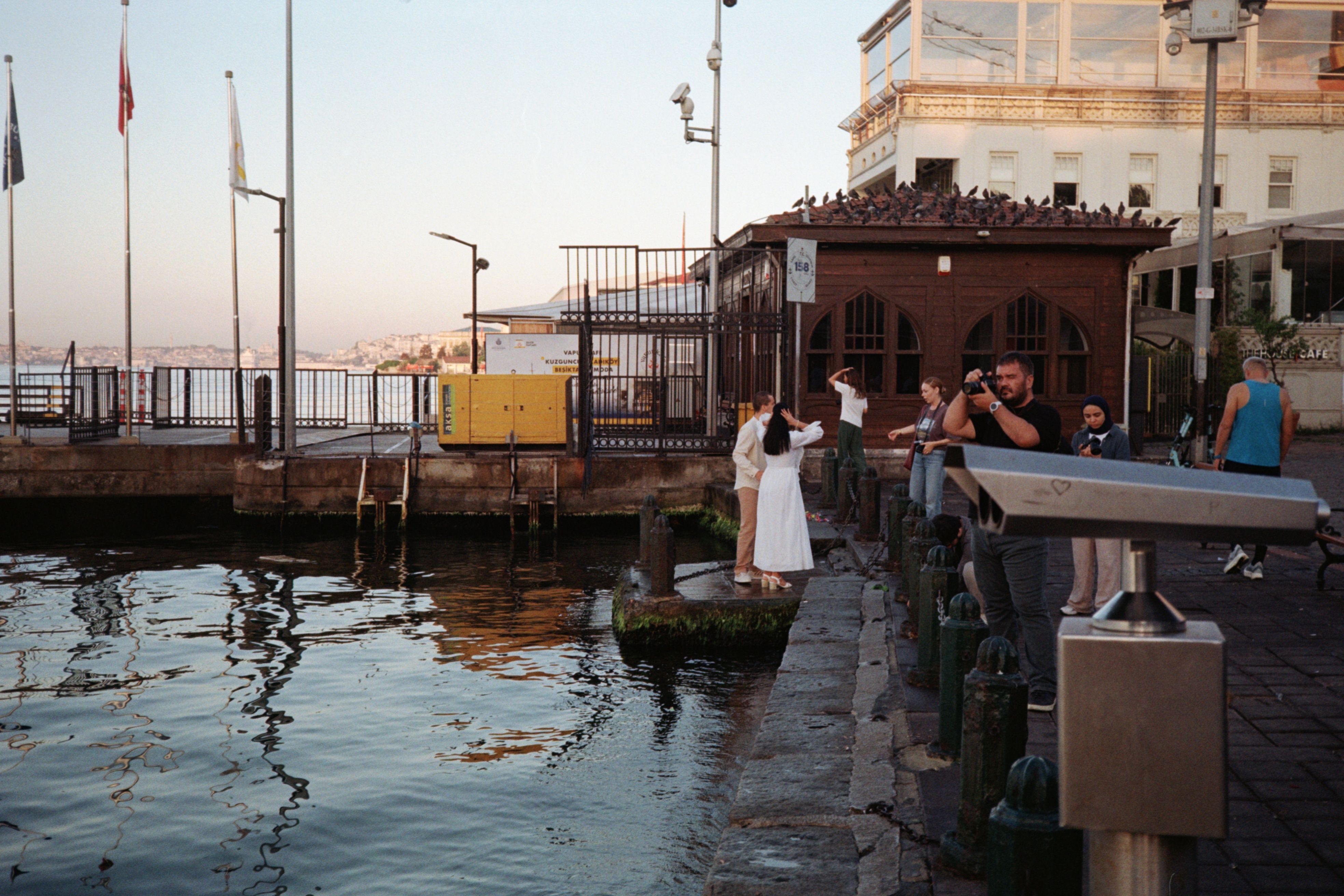 A group of people standing on the dock by the water · Free Stock Photo