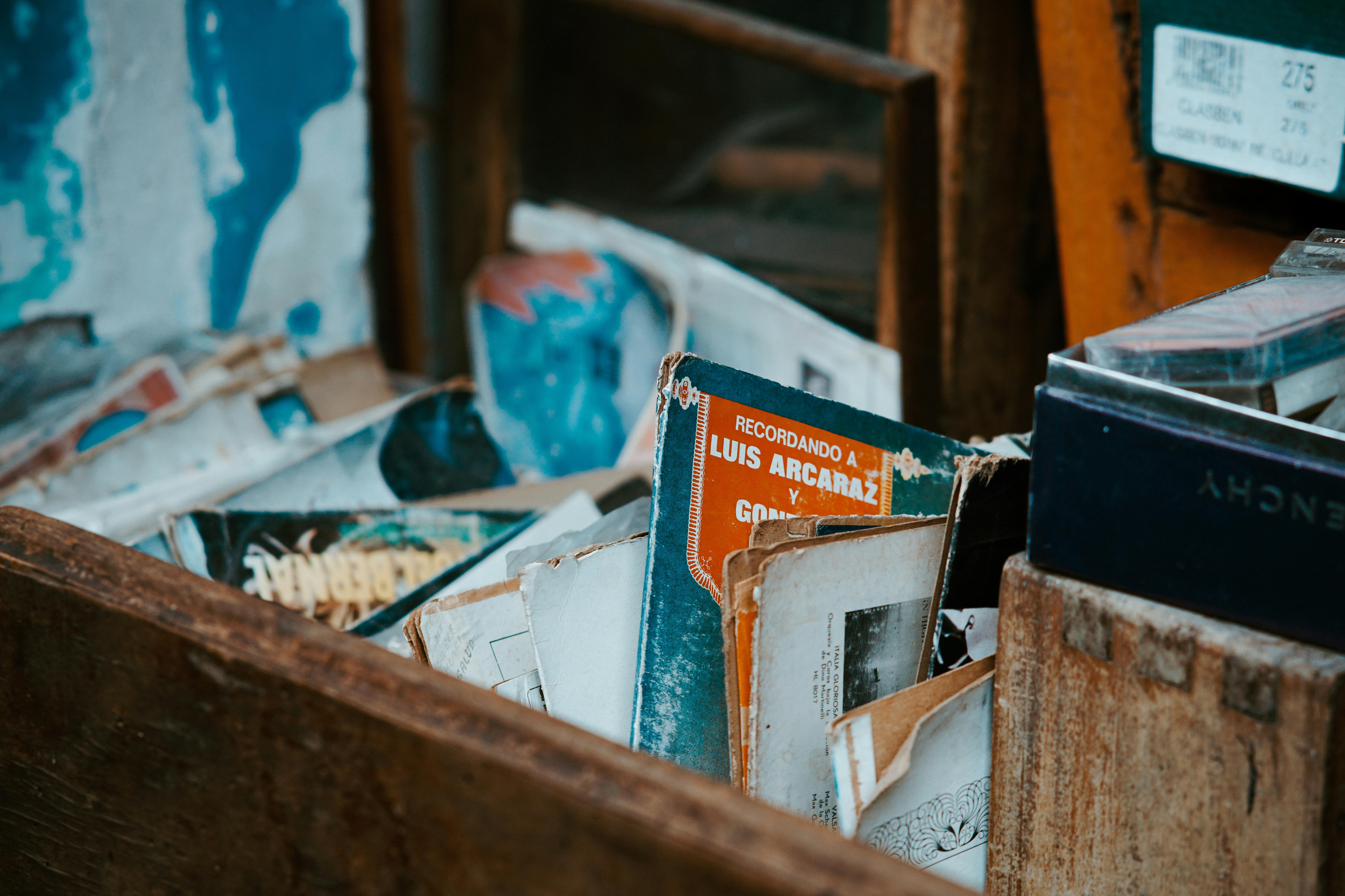A wooden box filled with old books and papers · Free Stock Photo