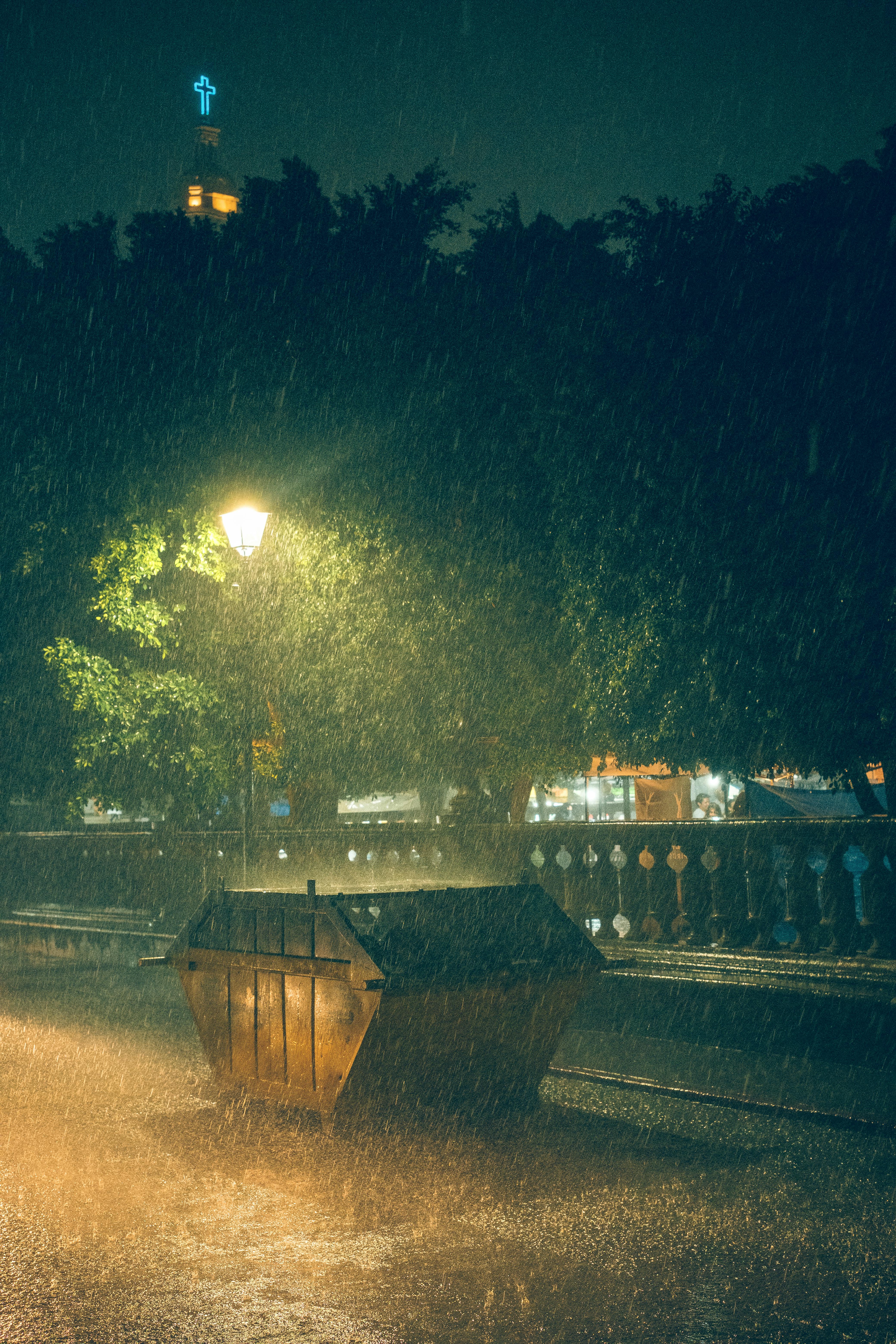 A street light is on in the rain · Free Stock Photo