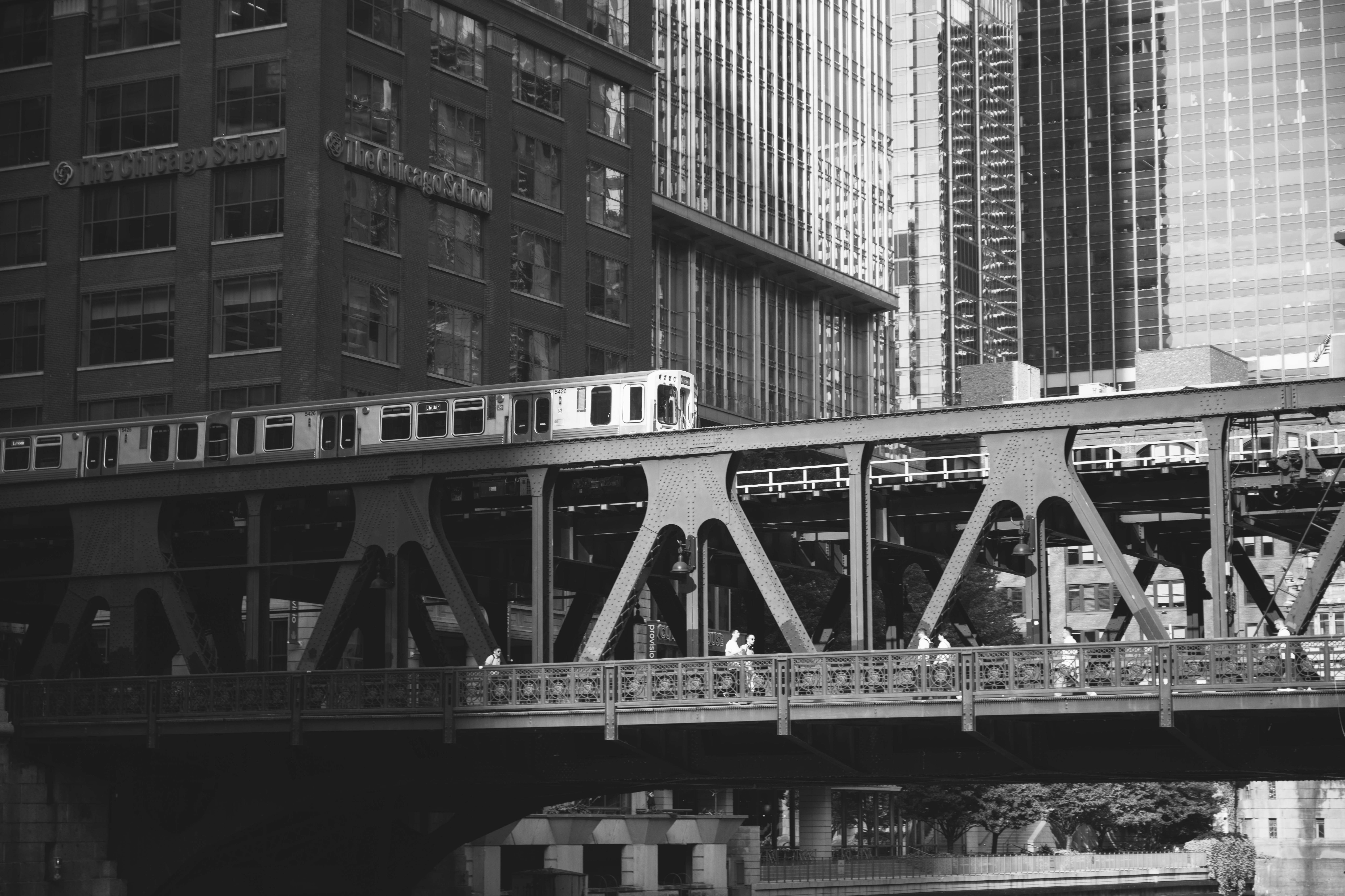 Black and white photo of train crossing over bridge · Free Stock Photo