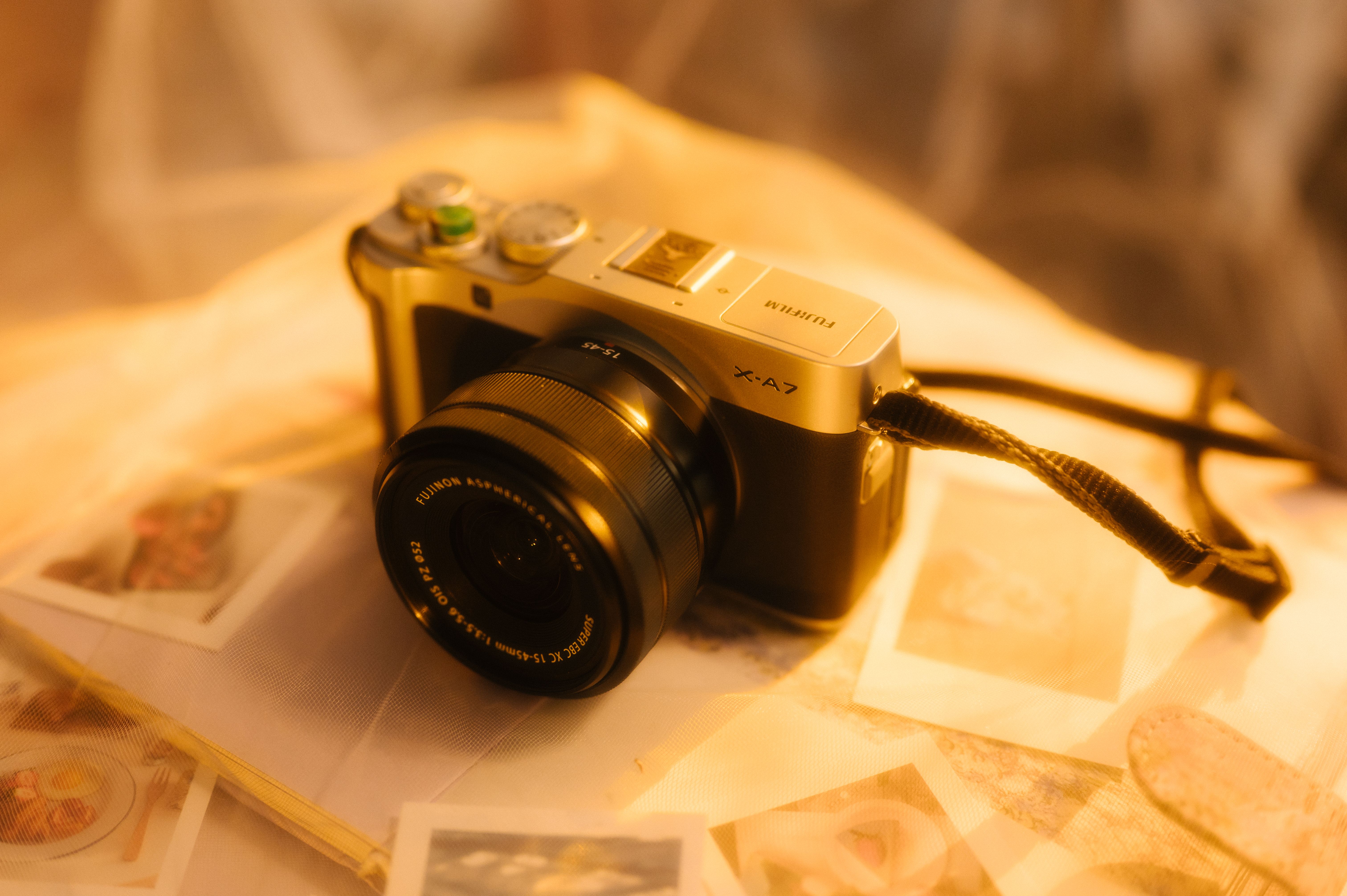 A camera sitting on top of a table with a bunch of pictures · Free ...