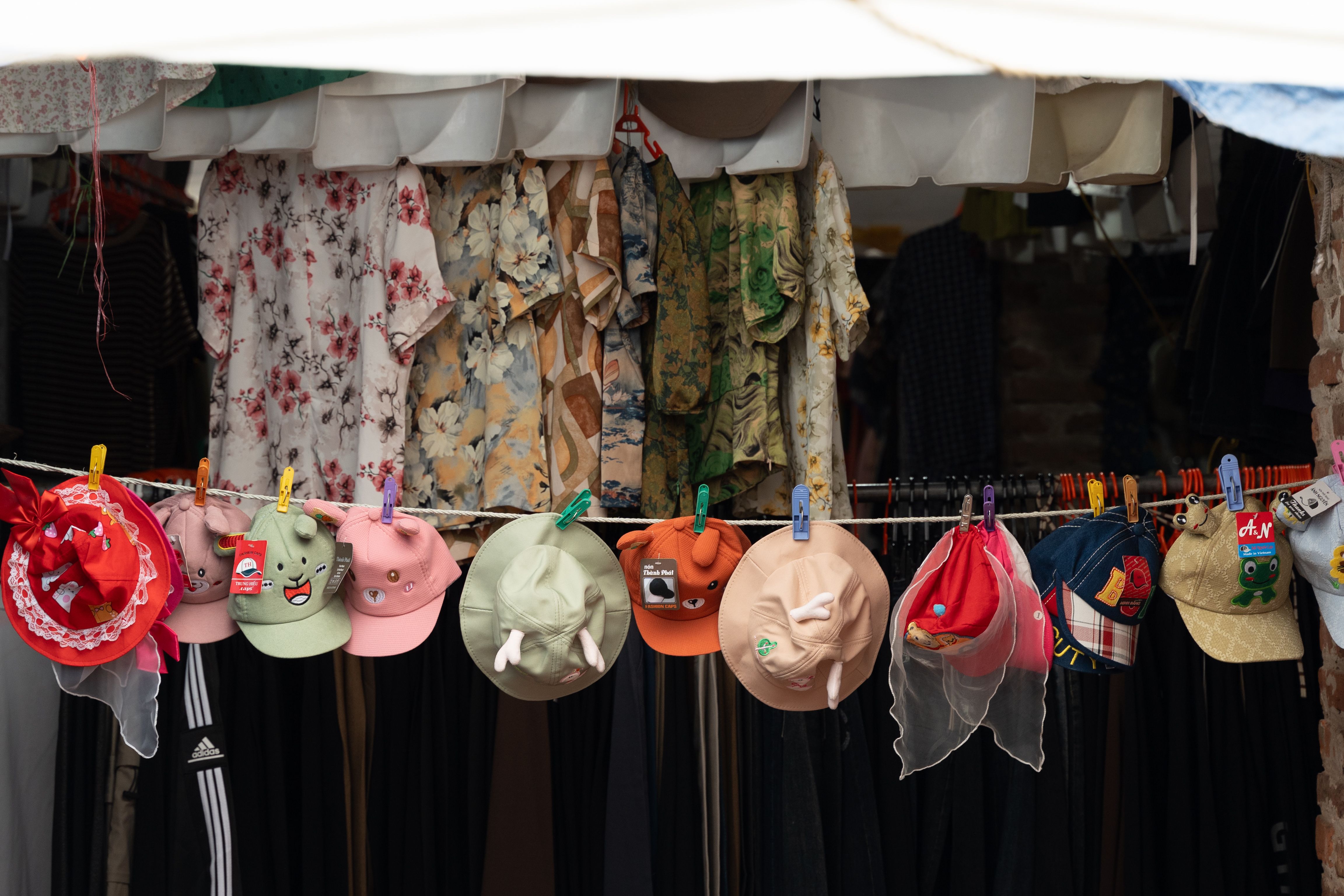 A bunch of hats hanging on clothes lines · Free Stock Photo