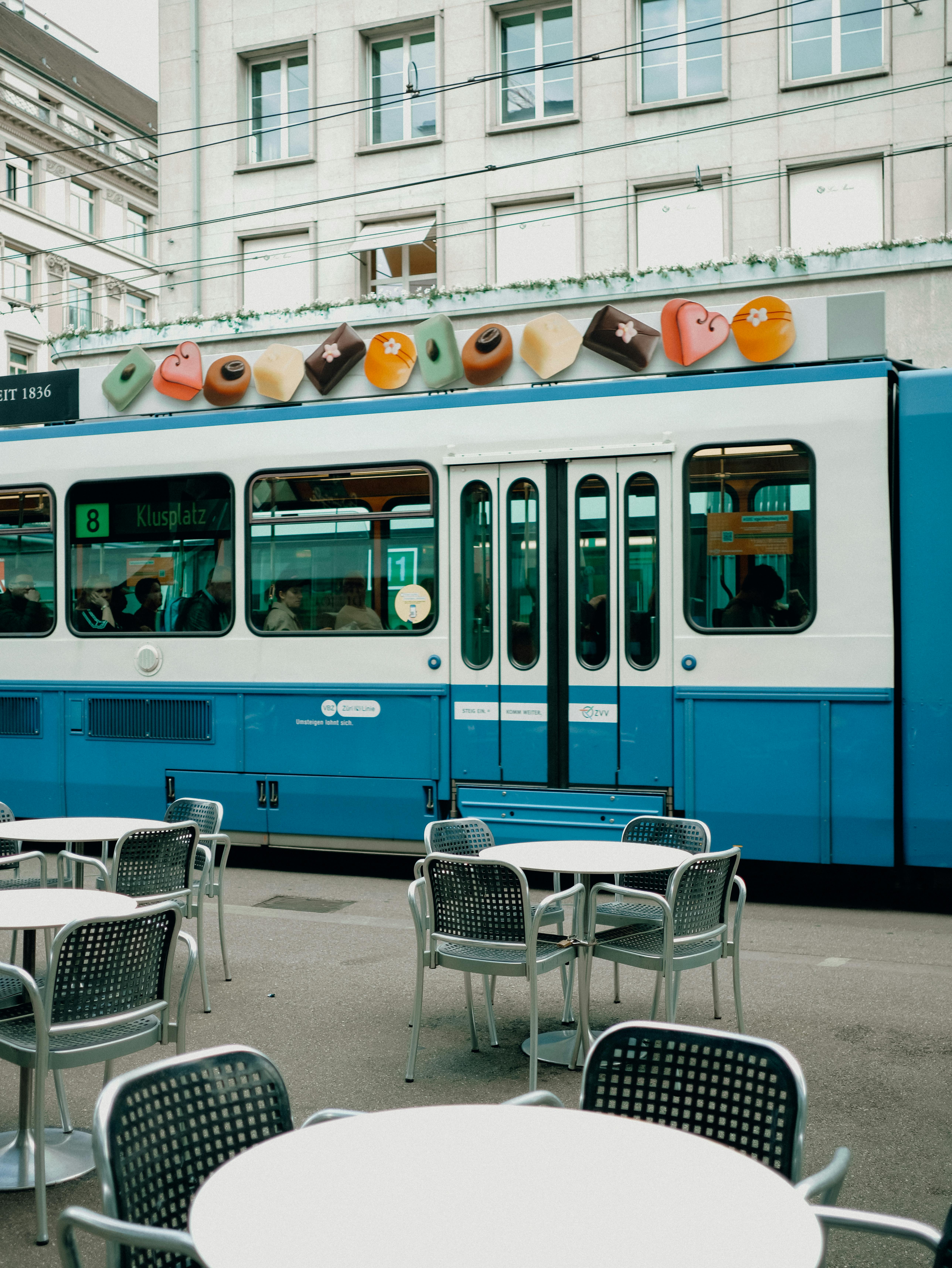 A blue and white bus with tables and chairs · Free Stock Photo