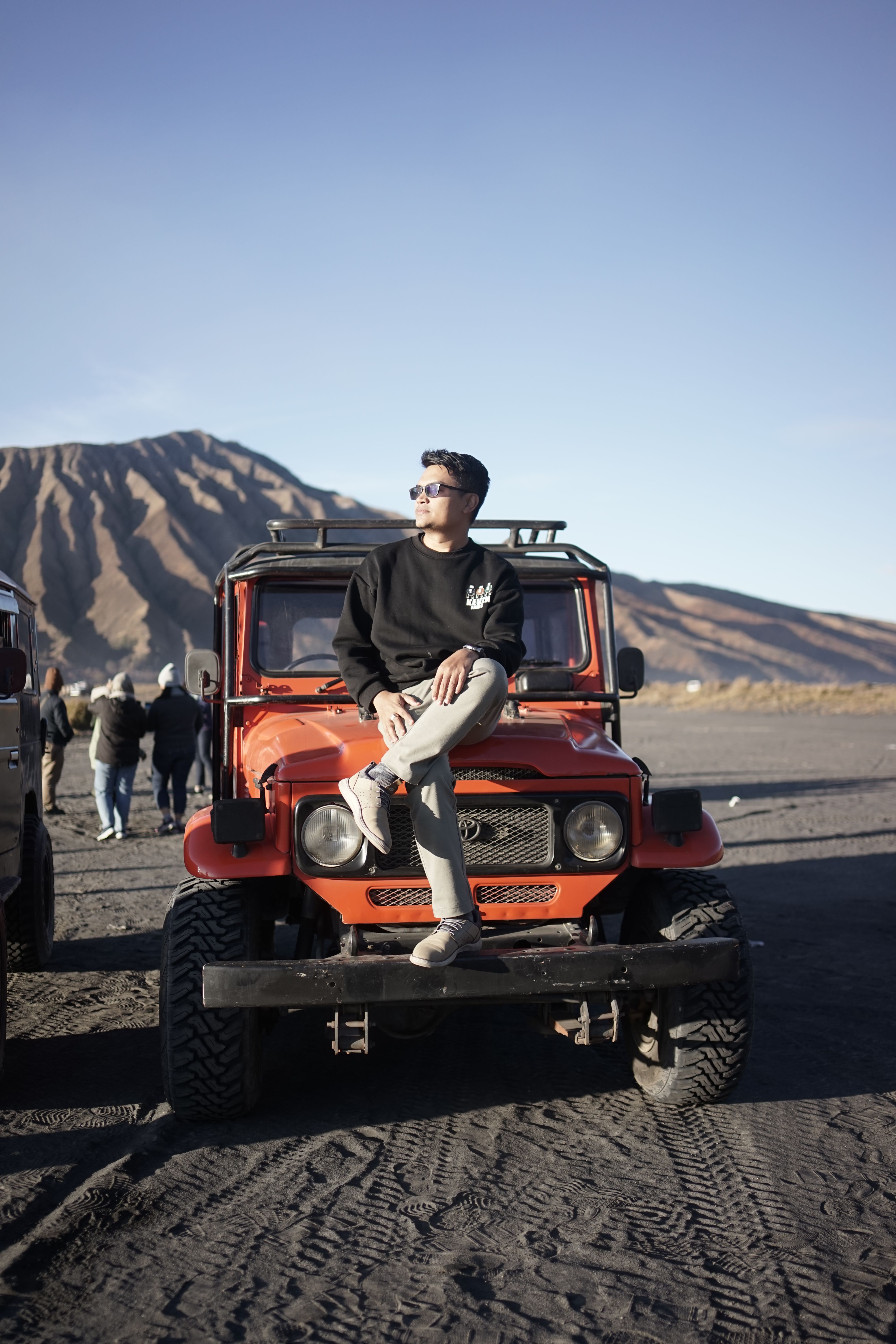 Man Sitting on the Hood of an Off Road Car and Taking a Picture · Free ...