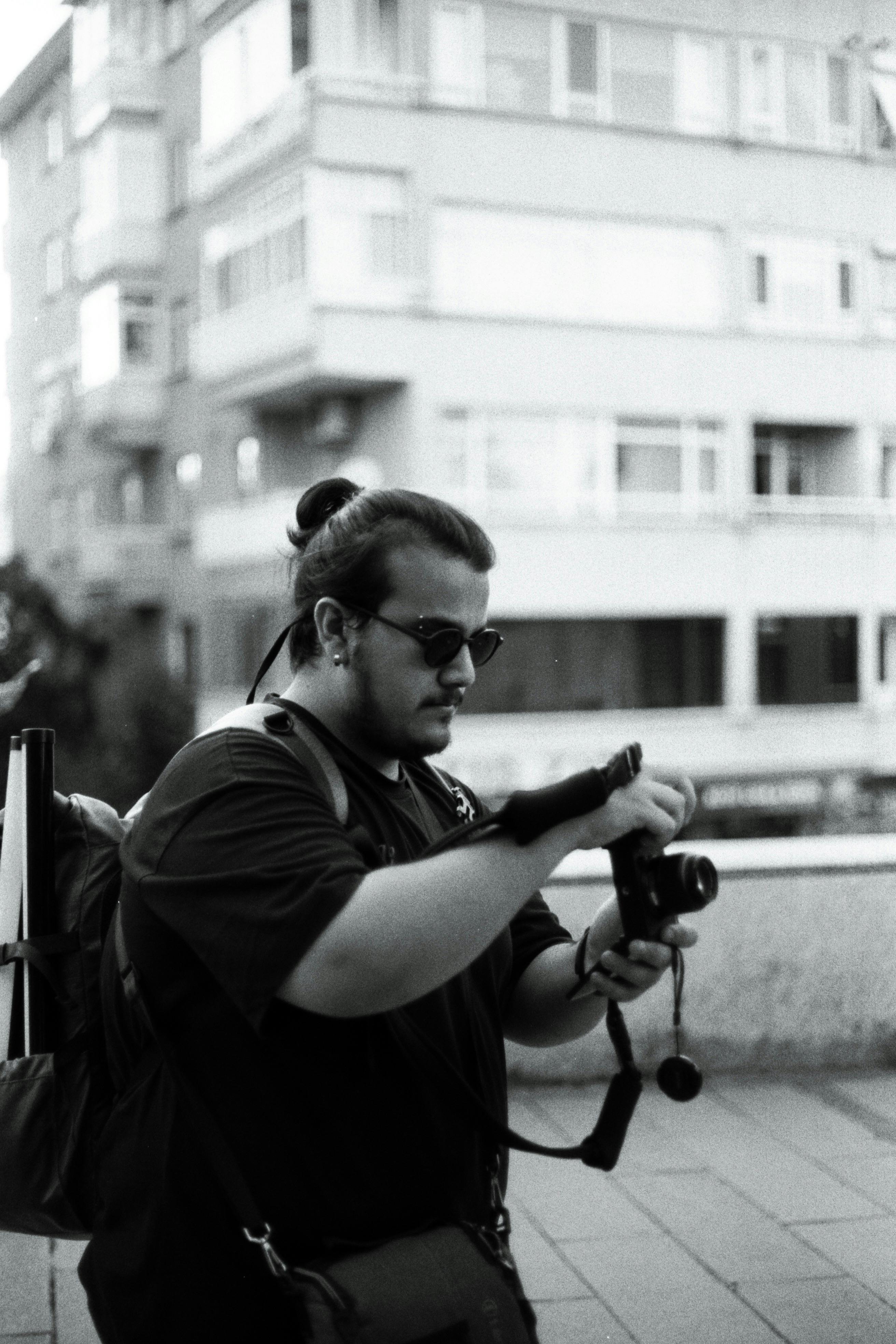 Gray Scale Photo of Man Holding Analog Camera · Free Stock Photo