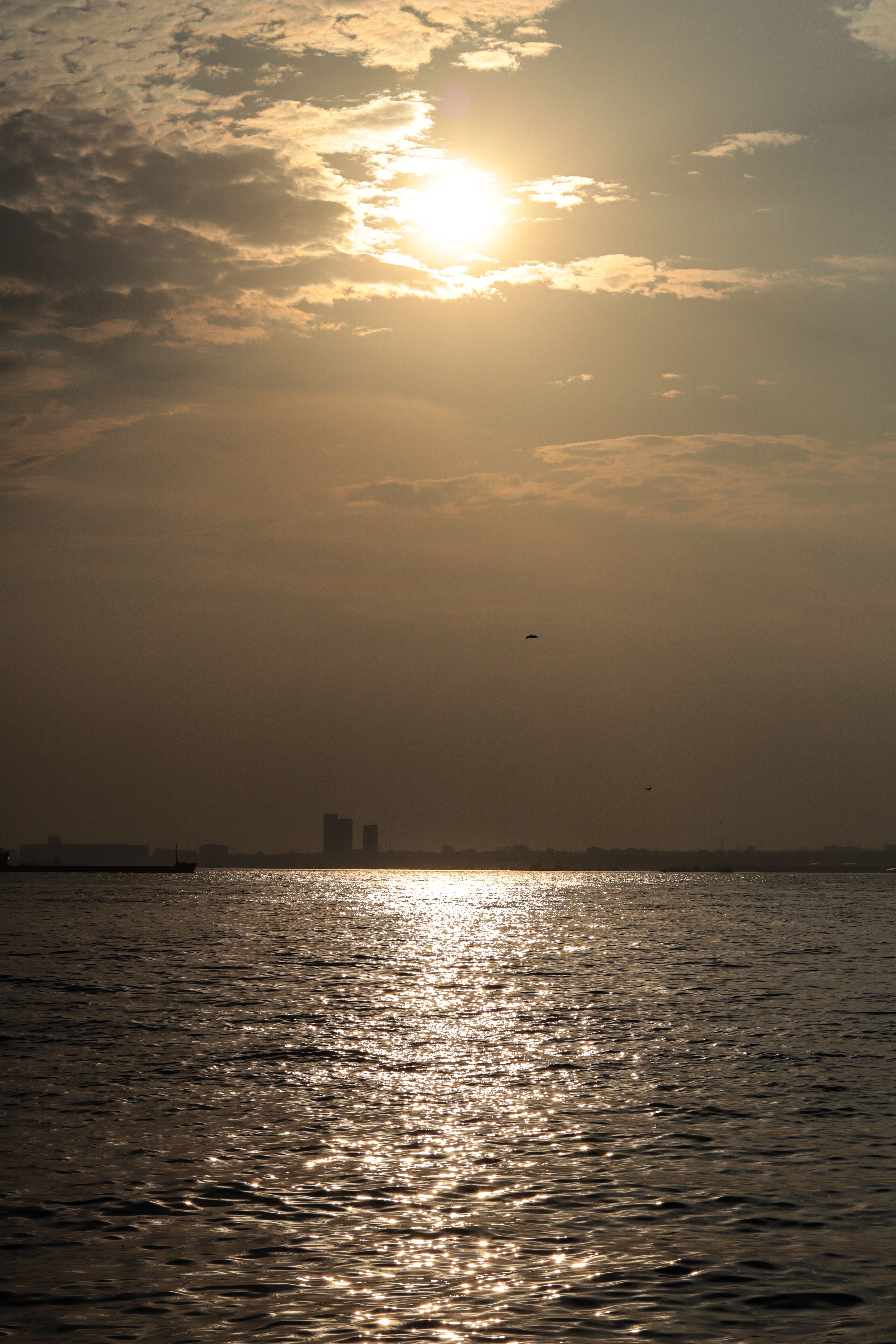 A view of the sun setting over the water · Free Stock Photo
