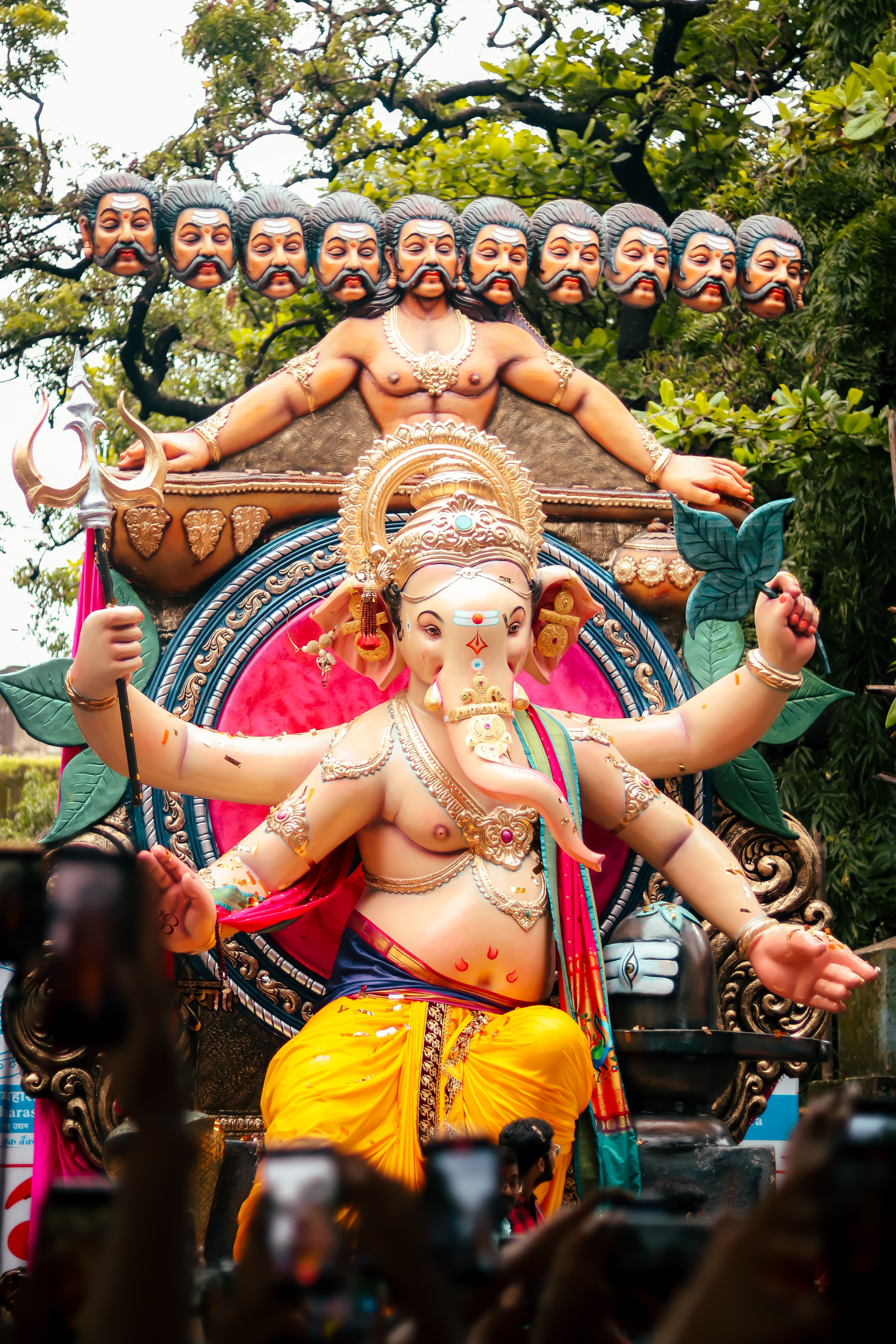 A large statue of ganesh is being held up by people · Free Stock Photo