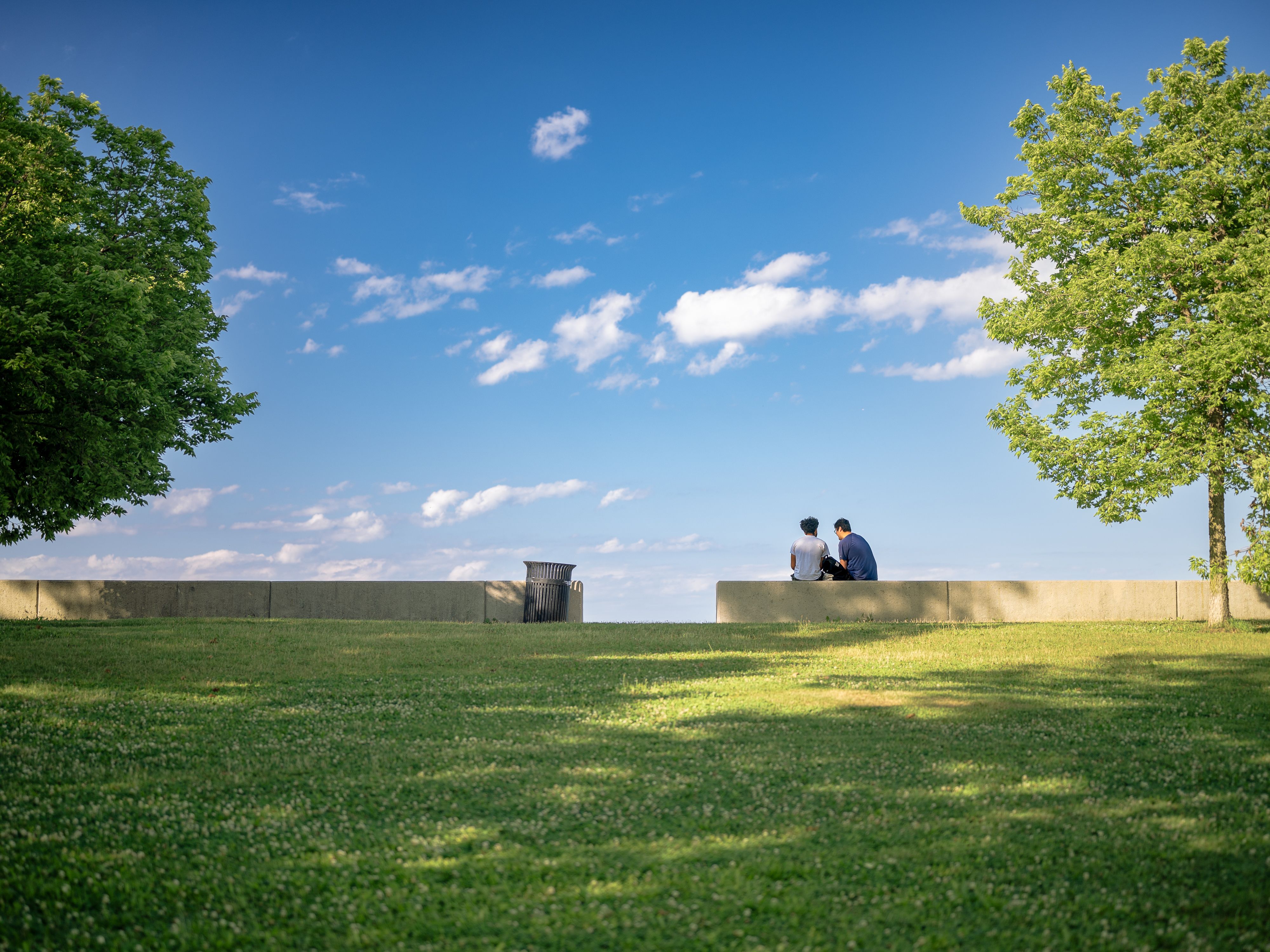 Two people sitting on a bench in a park · Free Stock Photo