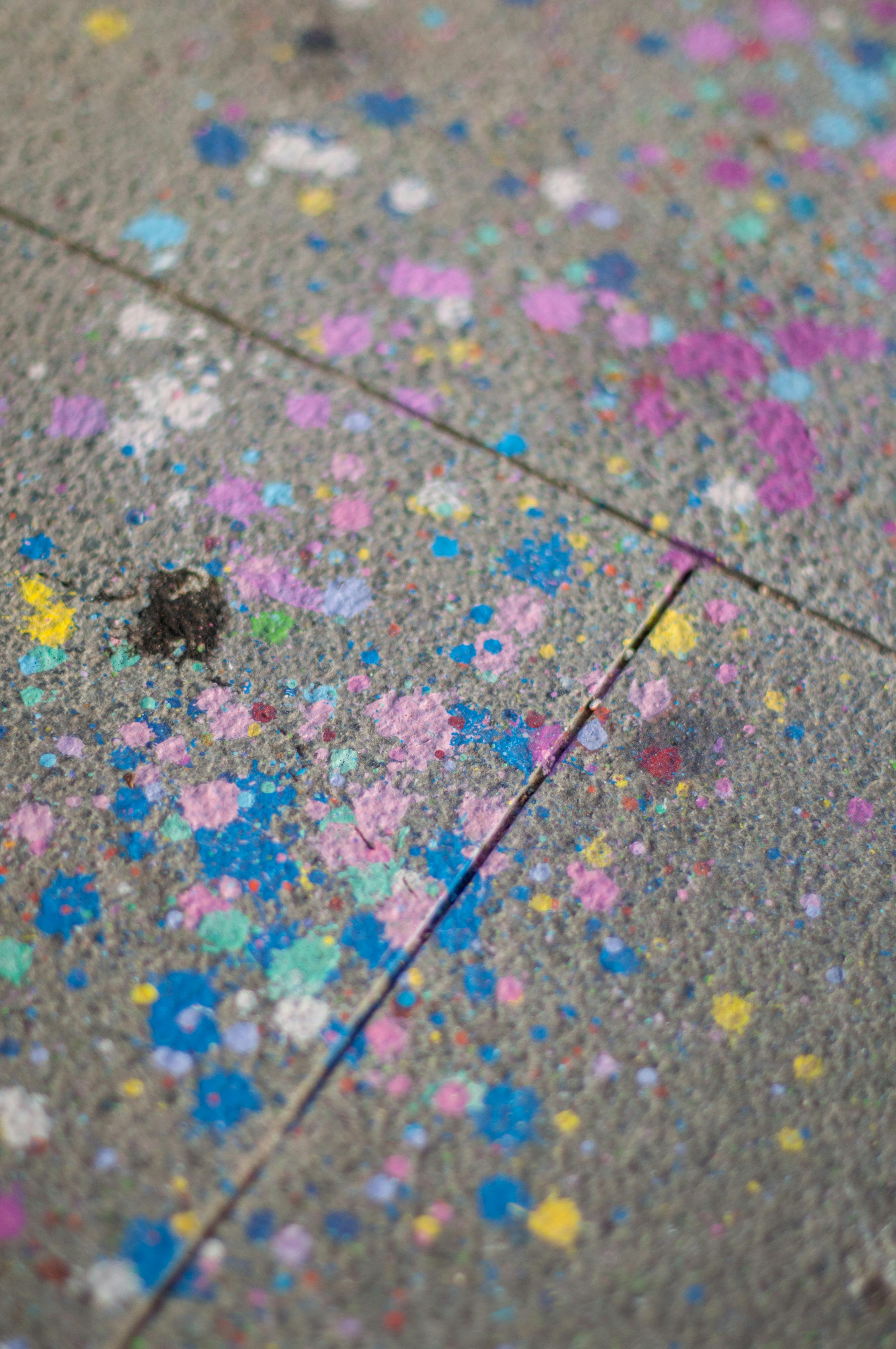 A close up of a colorful paint splatter on the floor · Free Stock Photo