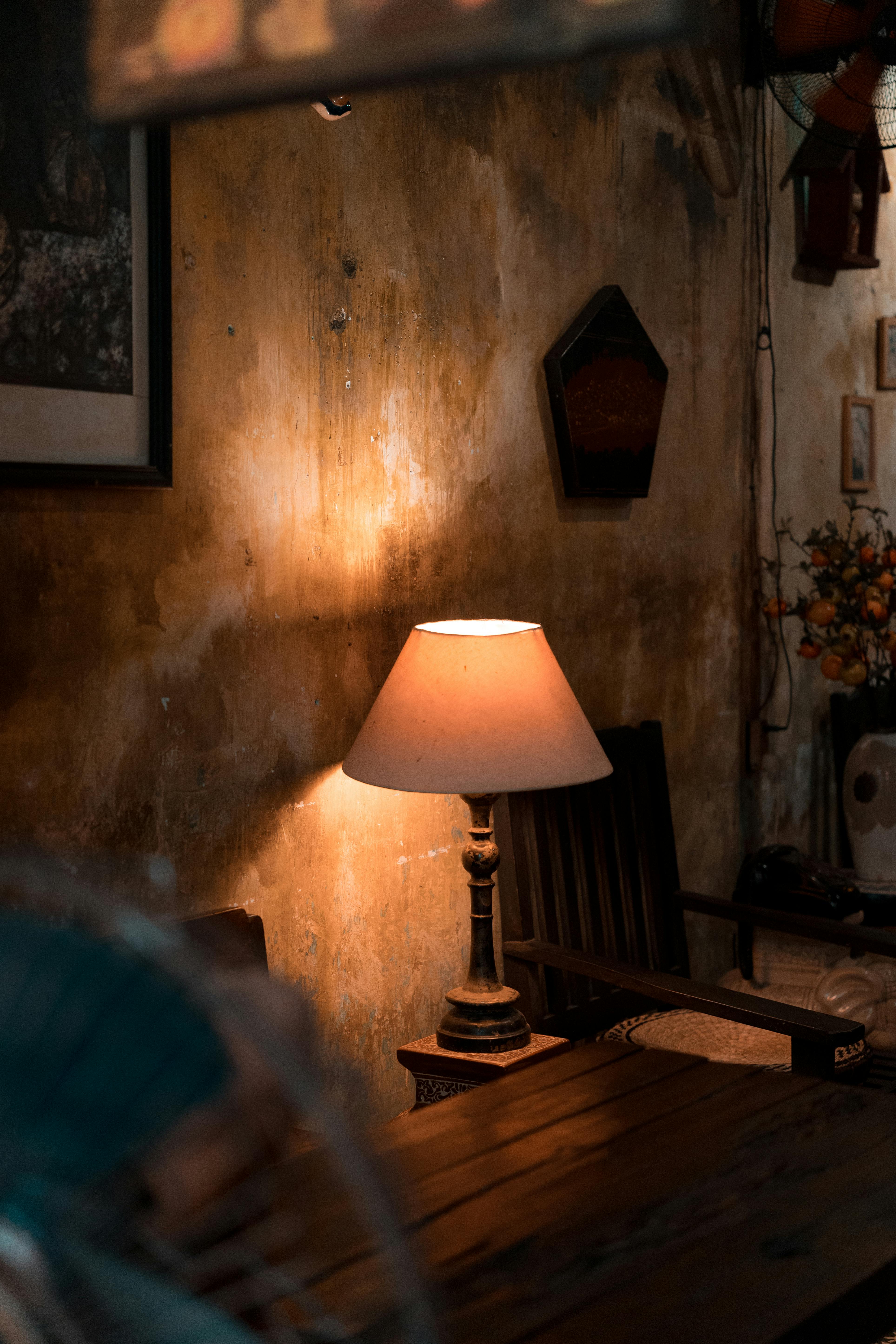A lamp is sitting on a table in a room · Free Stock Photo