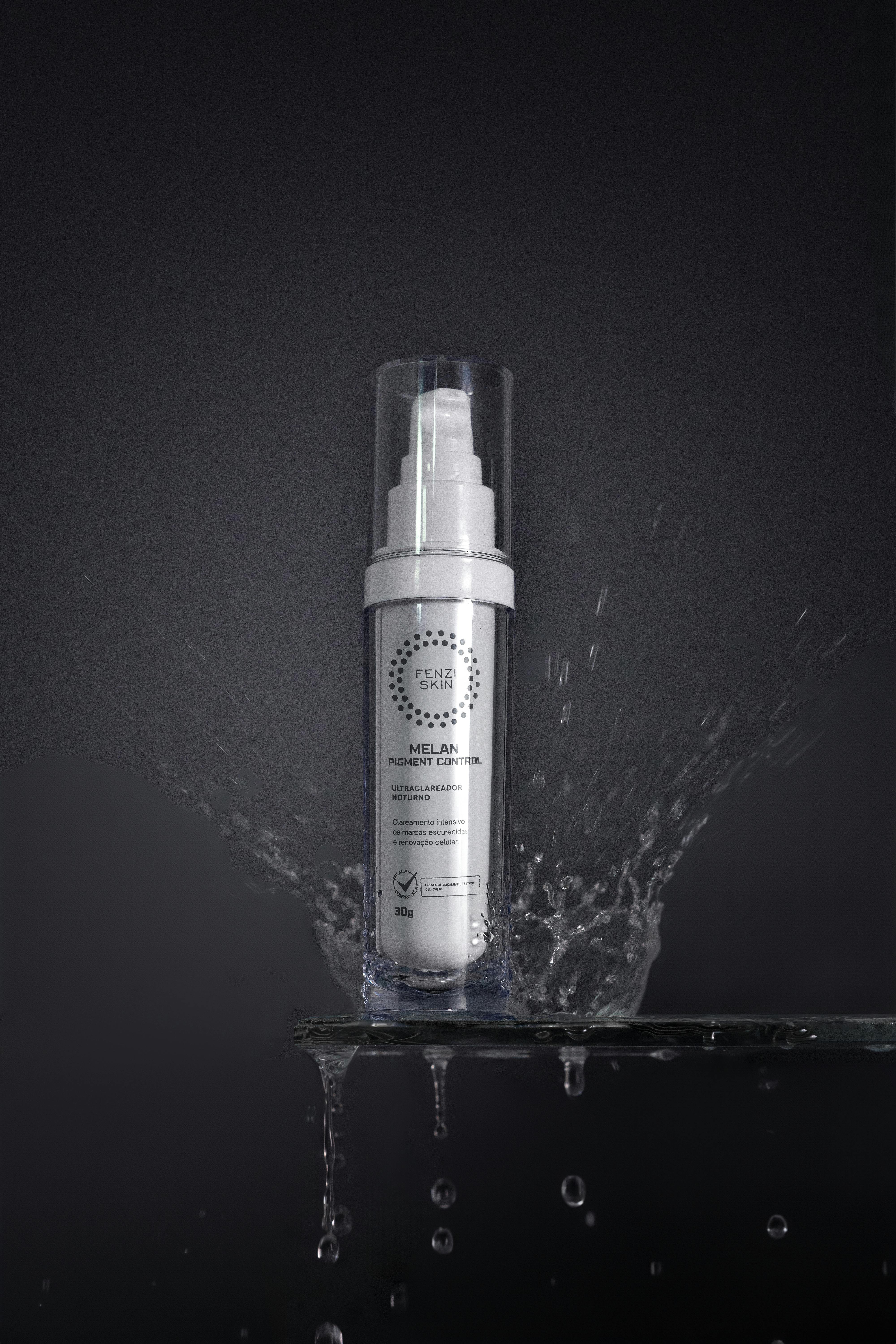 A bottle of skin care cream with water splashing on it · Free Stock Photo