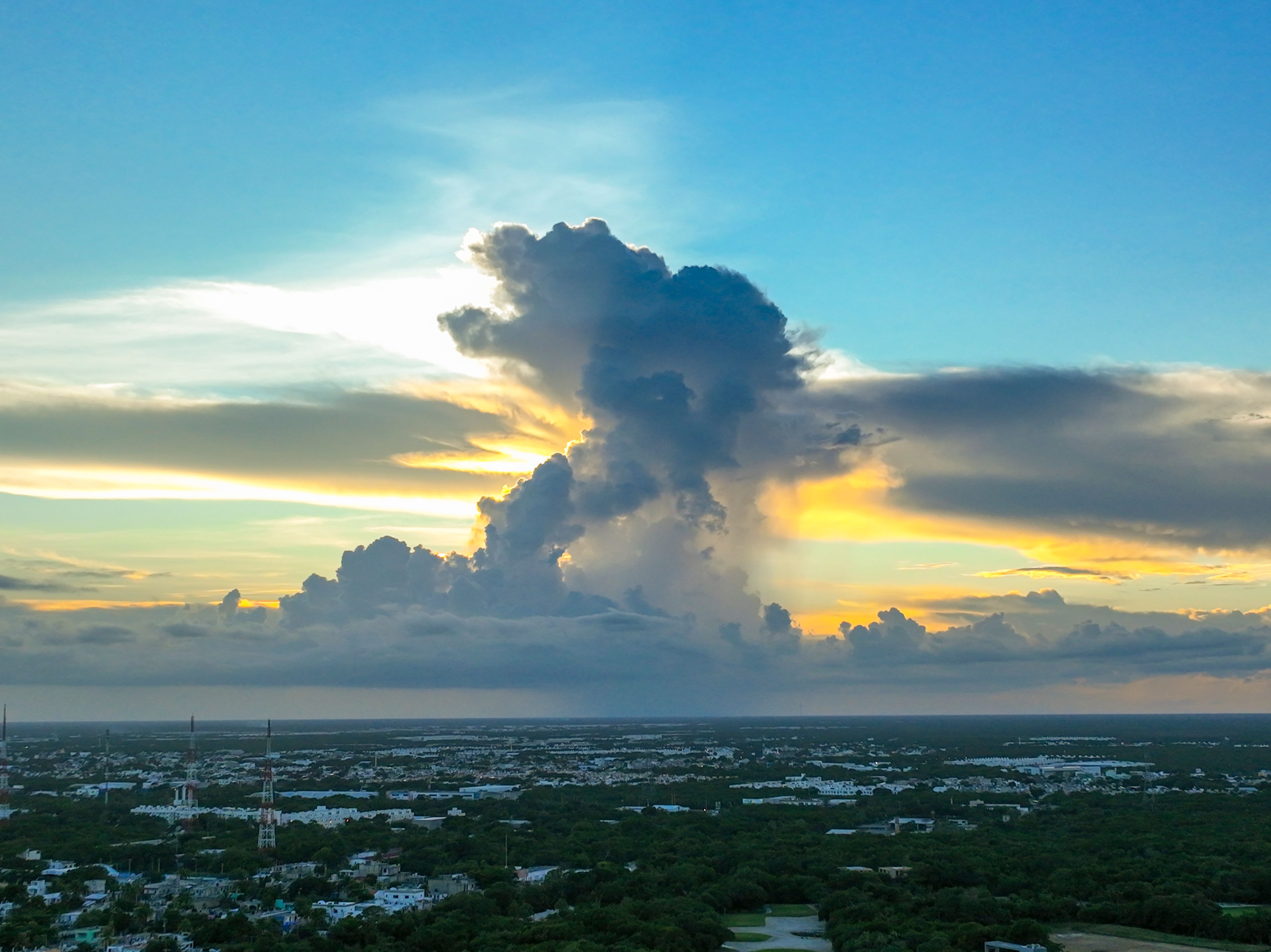 A view of a city and clouds at sunset · Free Stock Photo