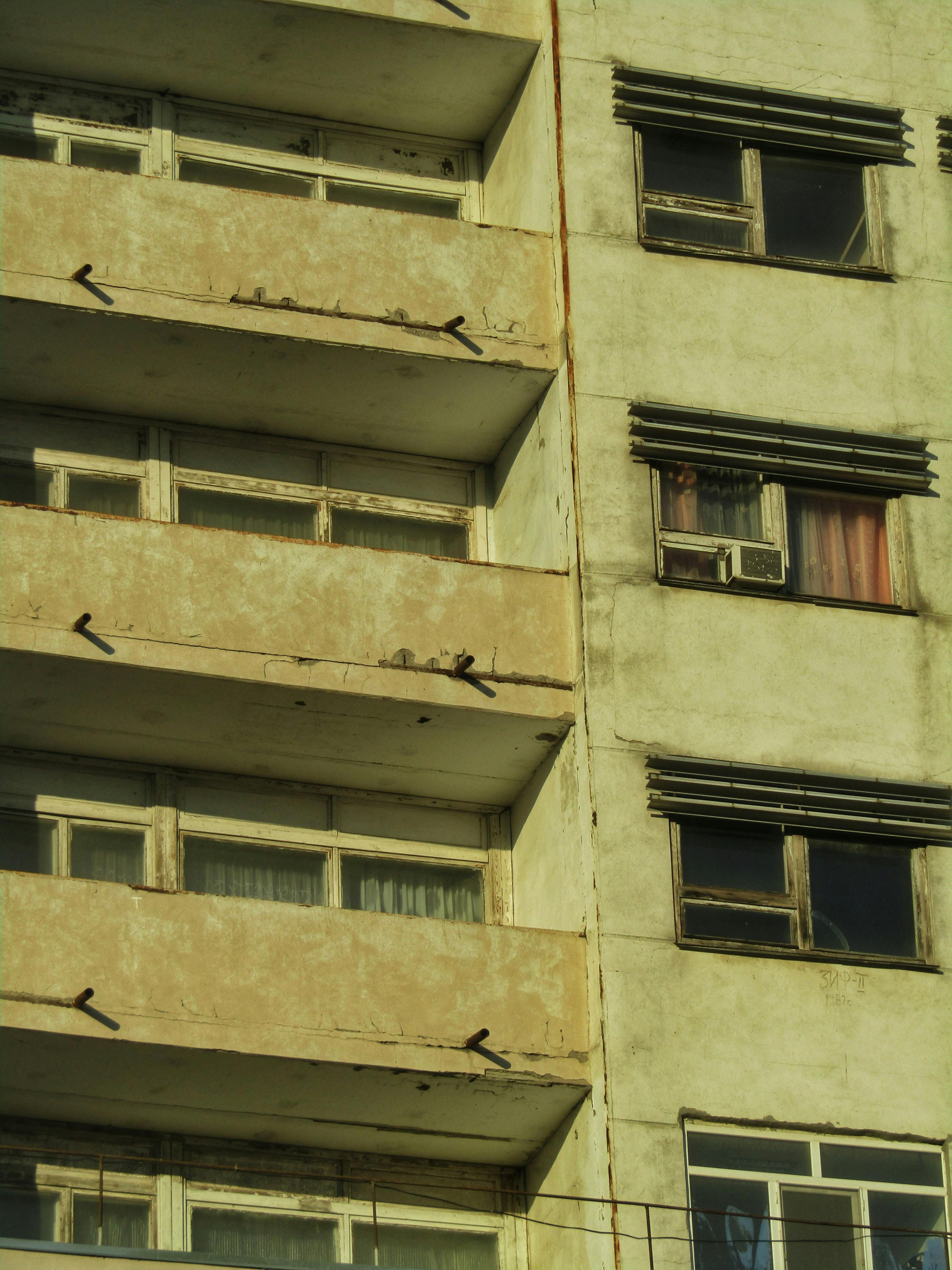 Low Angle Shot Of An Old Apartment Building Exterior With Worn Out ...