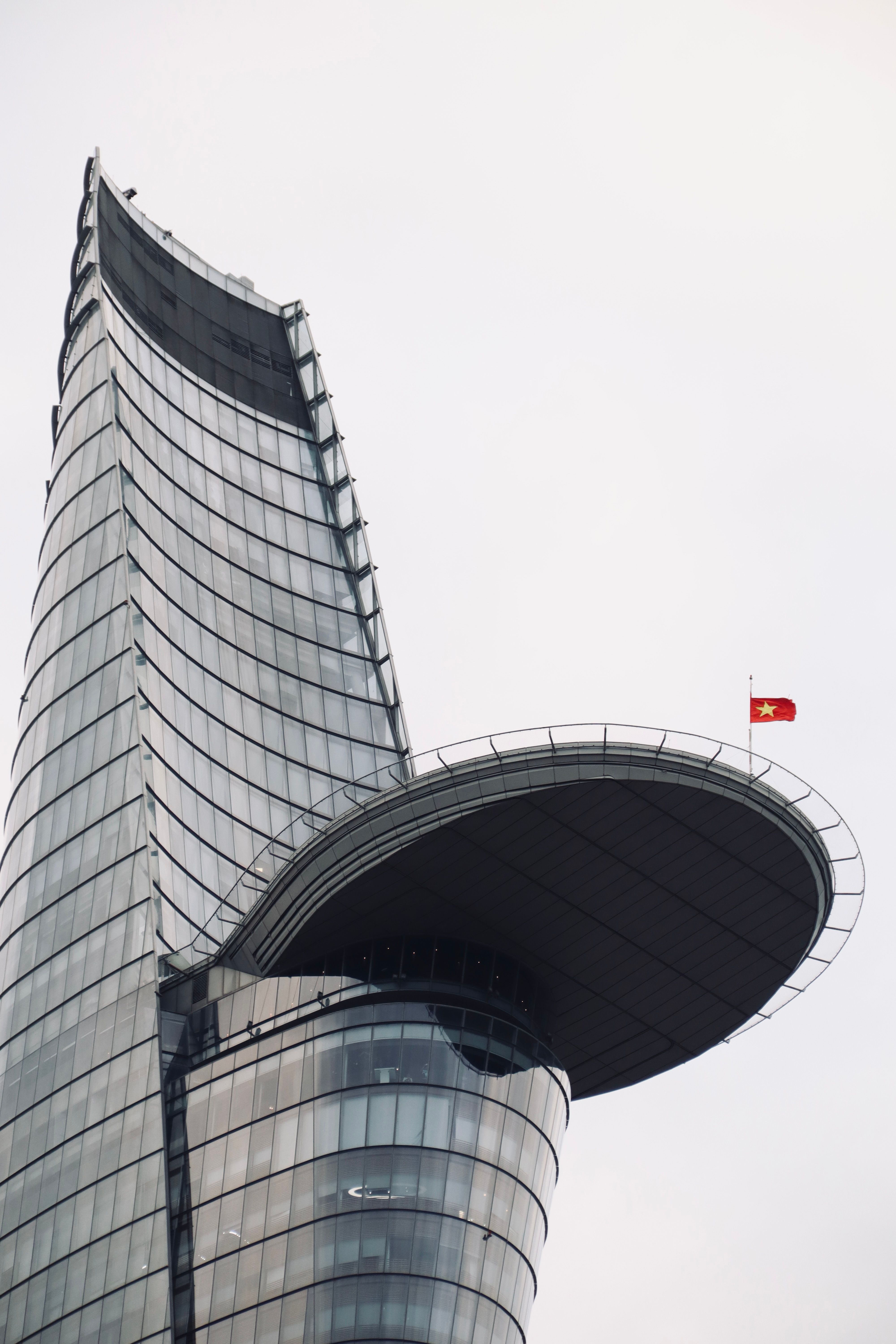 A red flag is flying in the air above a building · Free Stock Photo