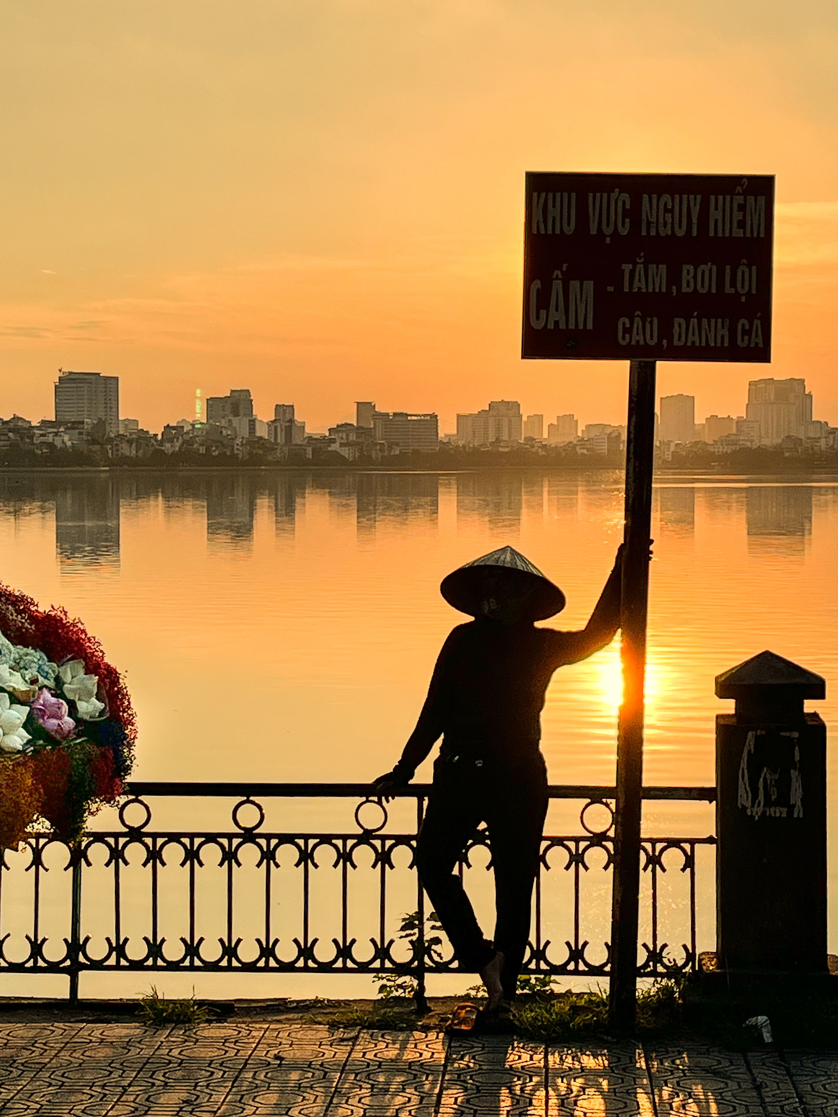A woman stands by a sign that says, 'hanoi' · Free Stock Photo