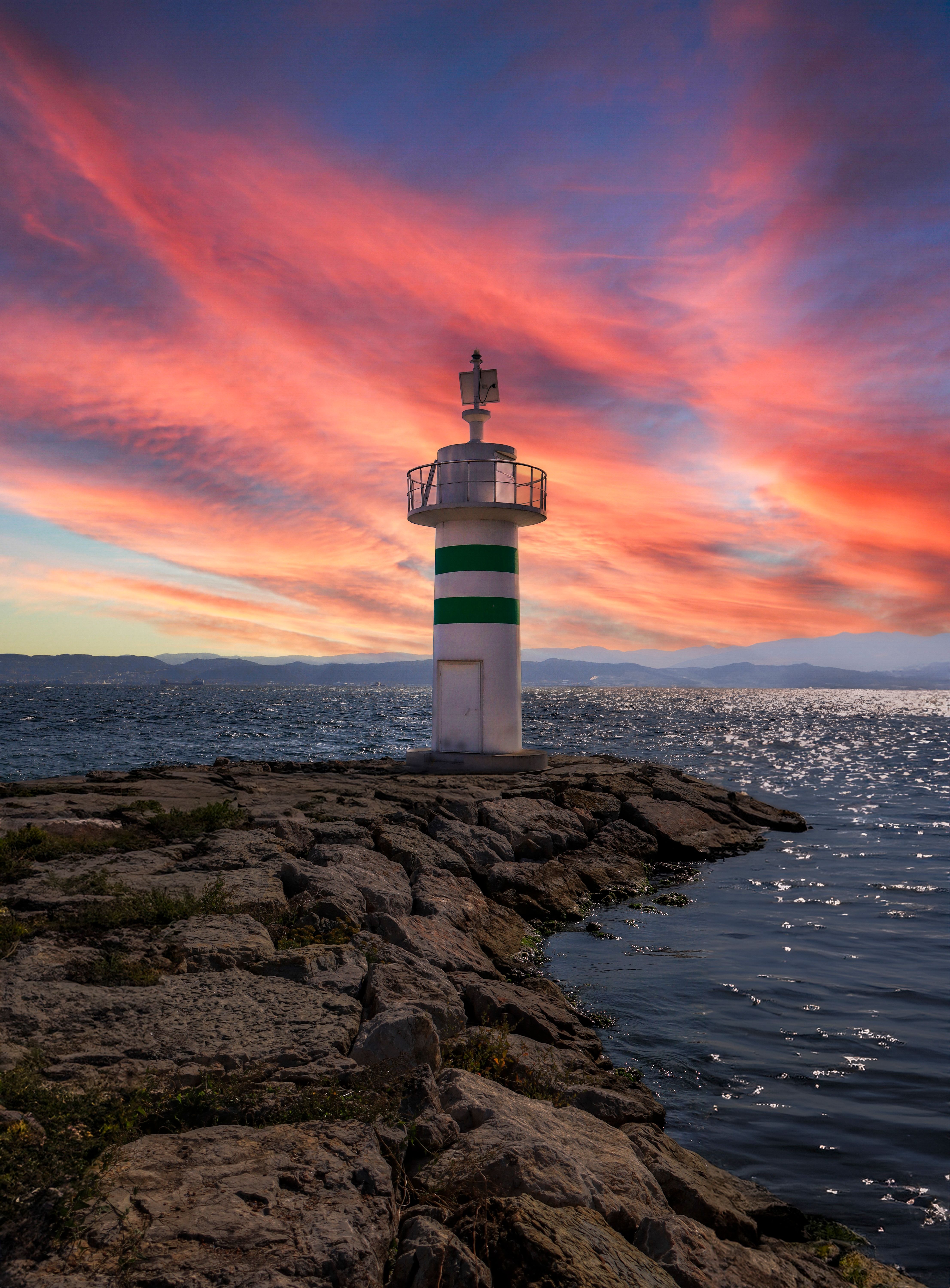 Light House Near Rock Formation Body of Water · Free Stock Photo