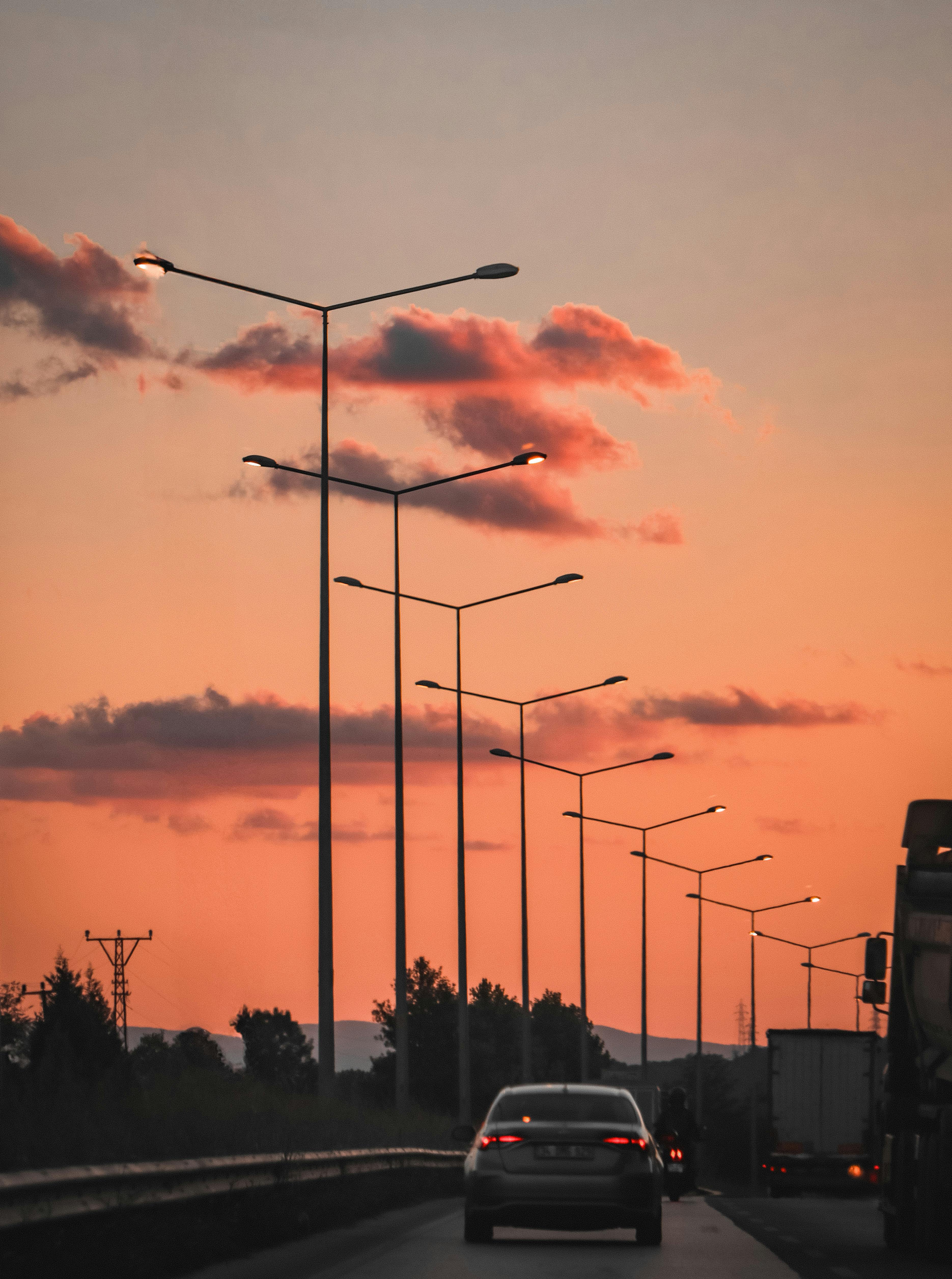 Sunset Drive with Streetlights and Clouds · Free Stock Photo