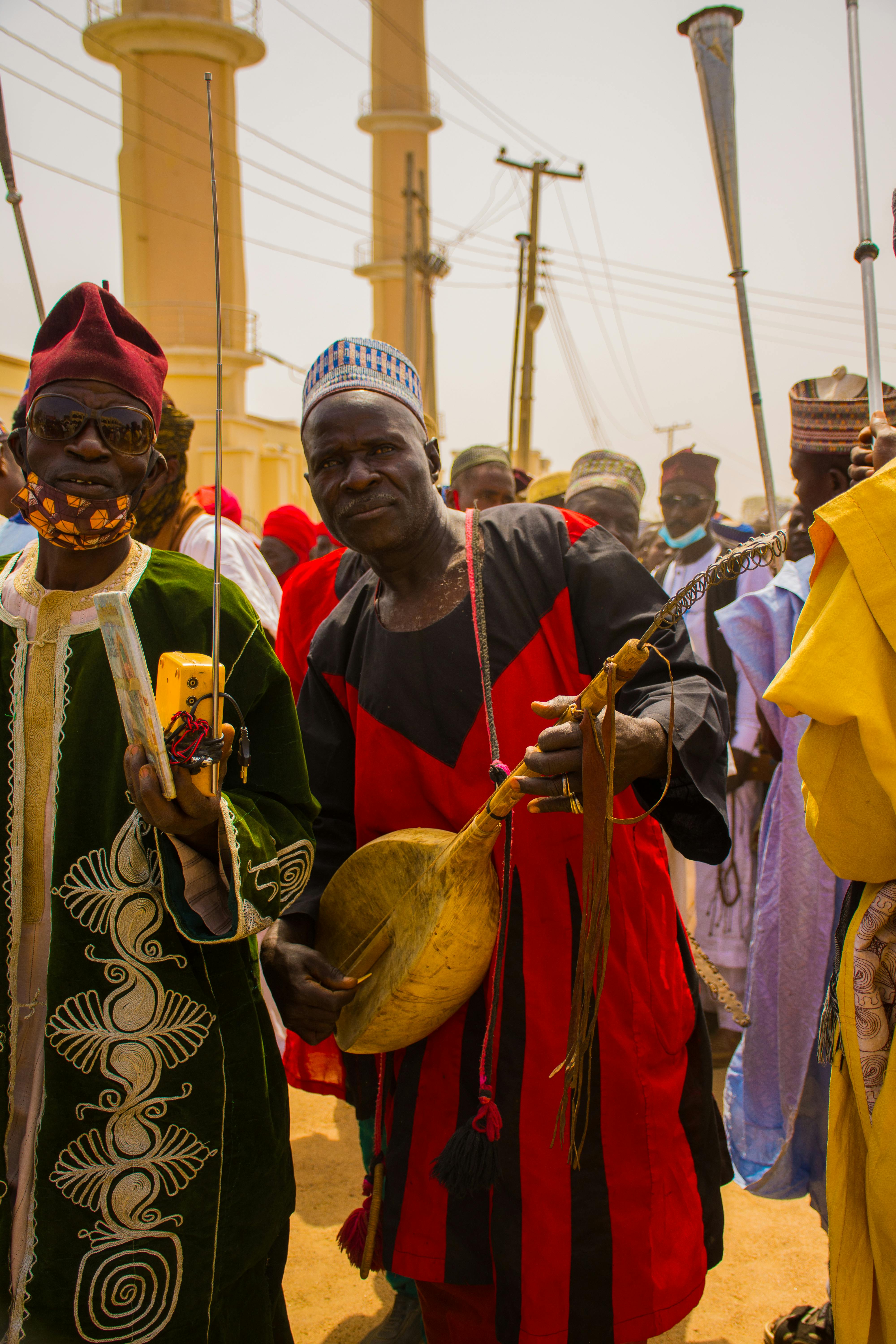 Two men in traditional clothing holding instruments · Free Stock Photo