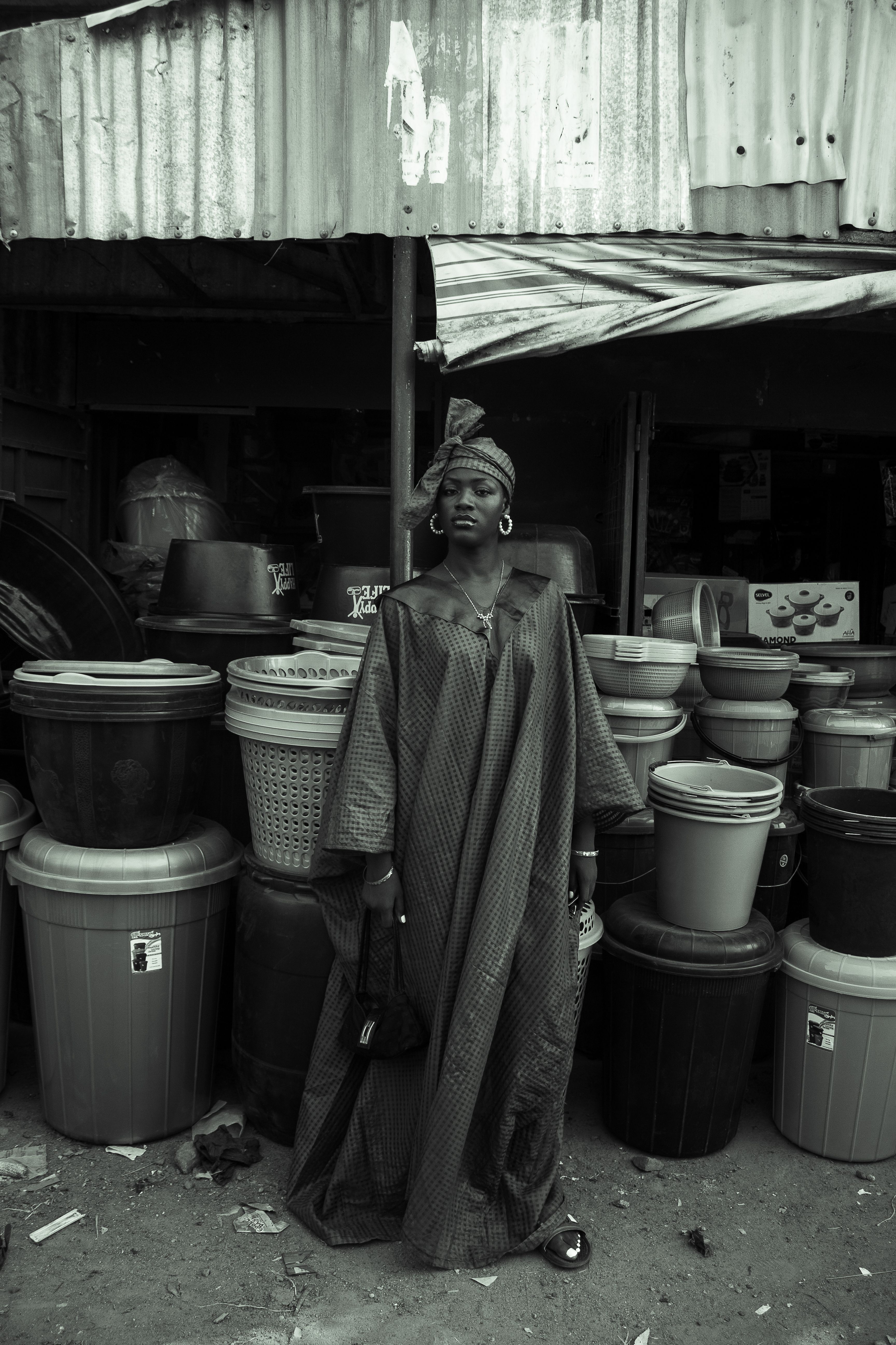 A woman standing in front of a pile of buckets · Free Stock Photo