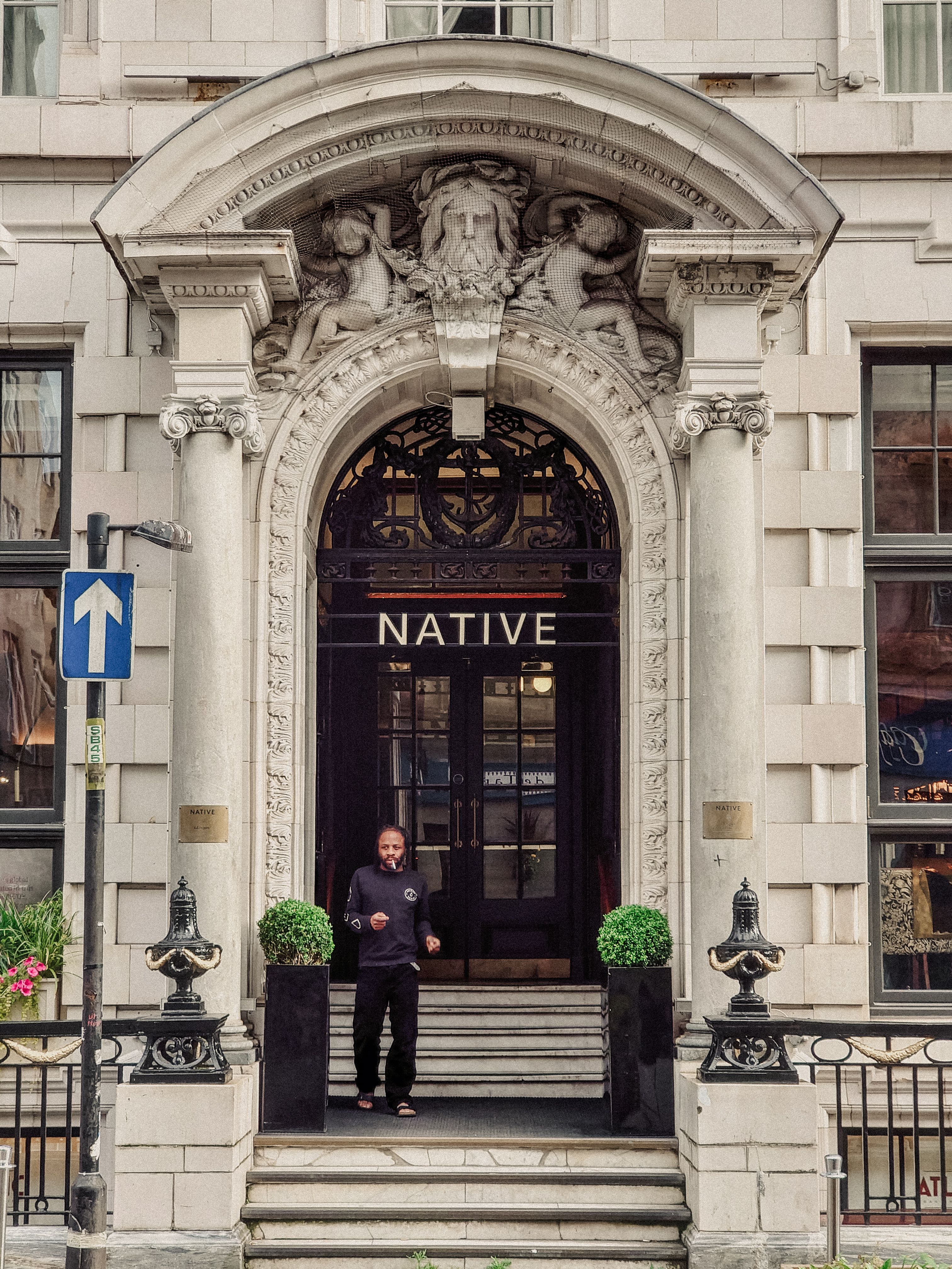 A man standing in front of a building with the word native · Free Stock ...