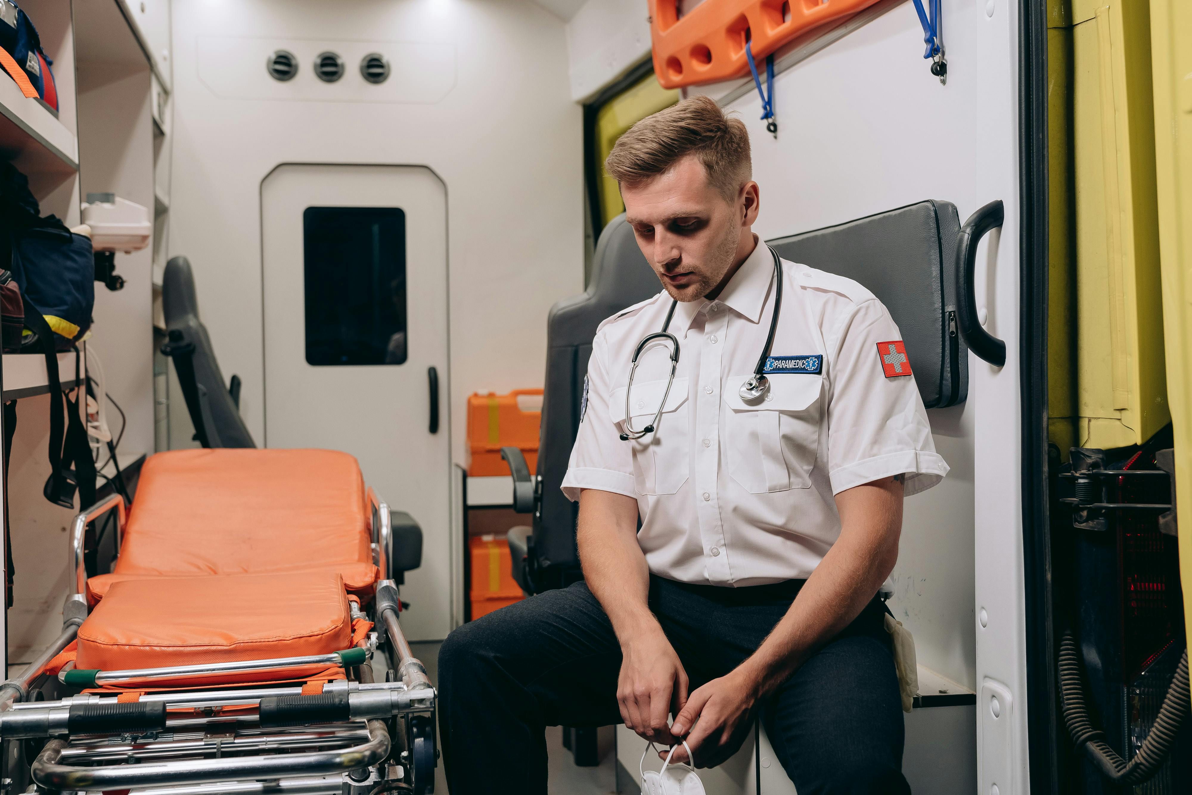 Paramedic Sitting in the Back of an Ambulance with His Eyes Closed ...