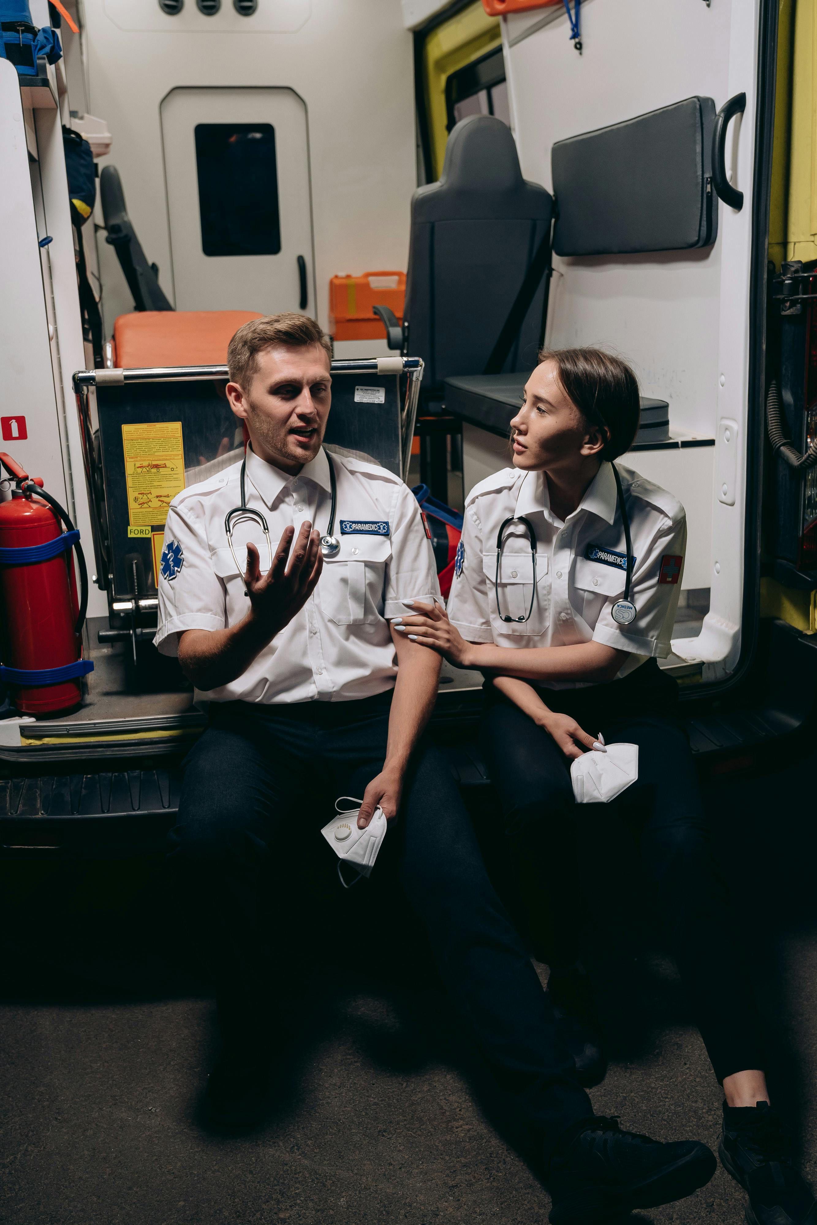 Paramedics Sitting in Ambulance · Free Stock Photo
