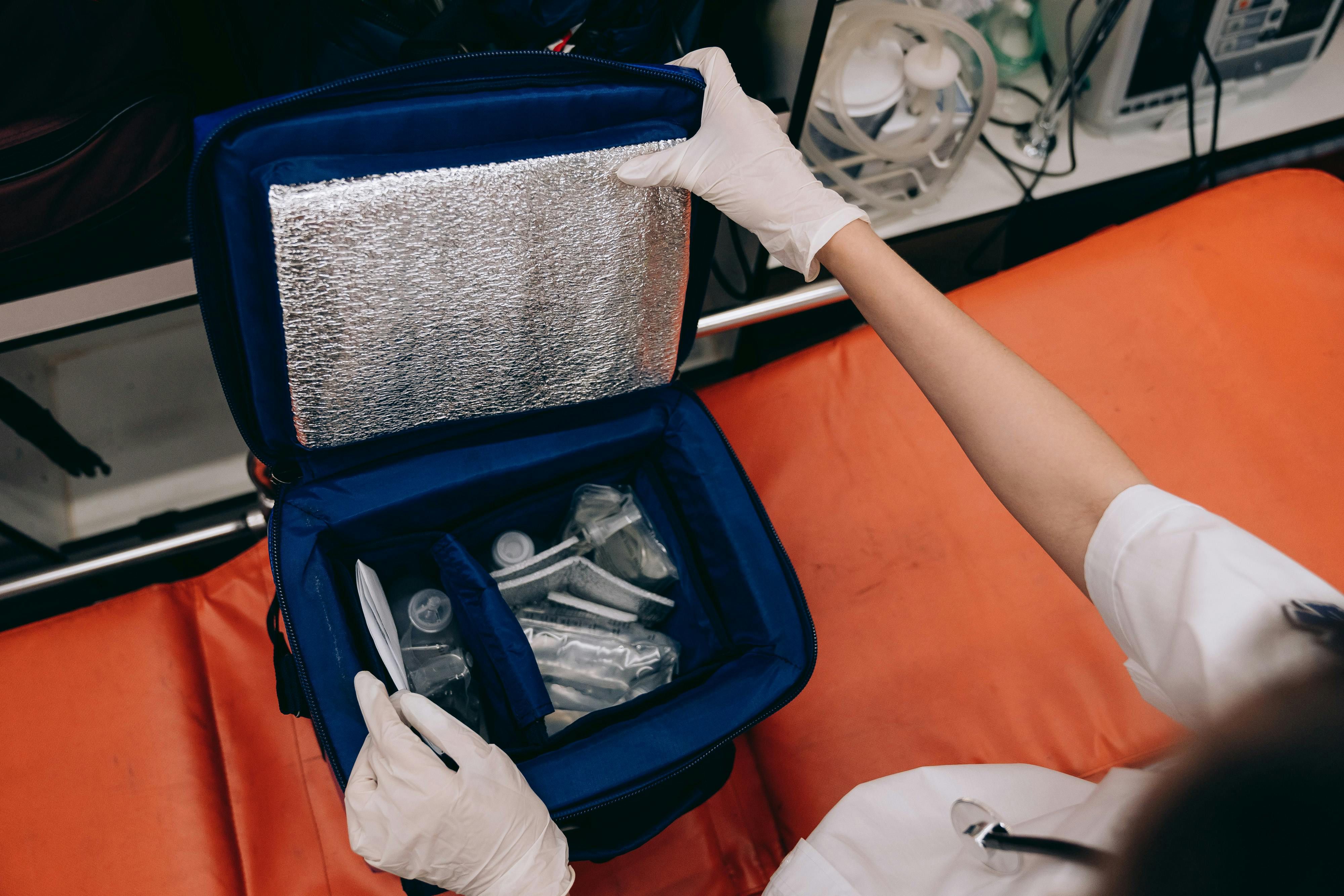 Paramedic Checking a Bag with Medical Equipment · Free Stock Photo