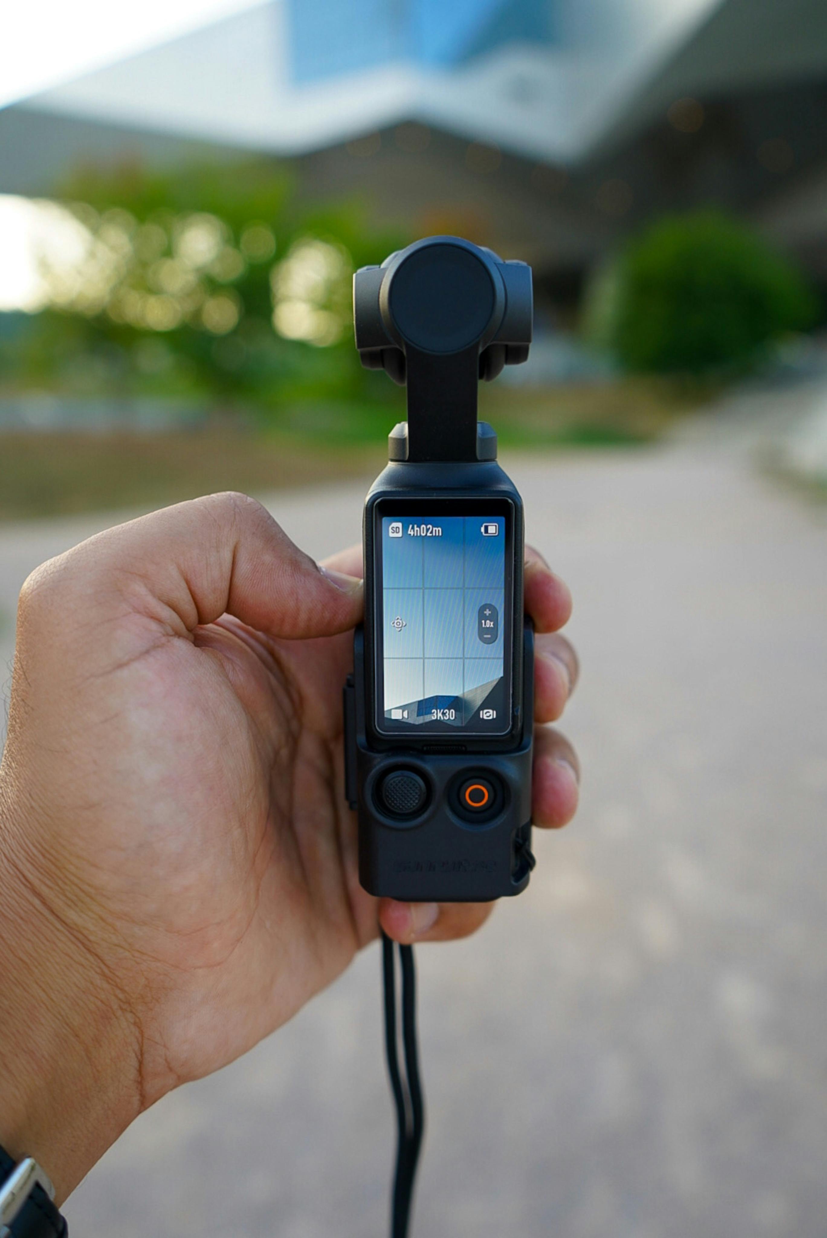 A person holding a gopro camera in their hand · Free Stock Photo
