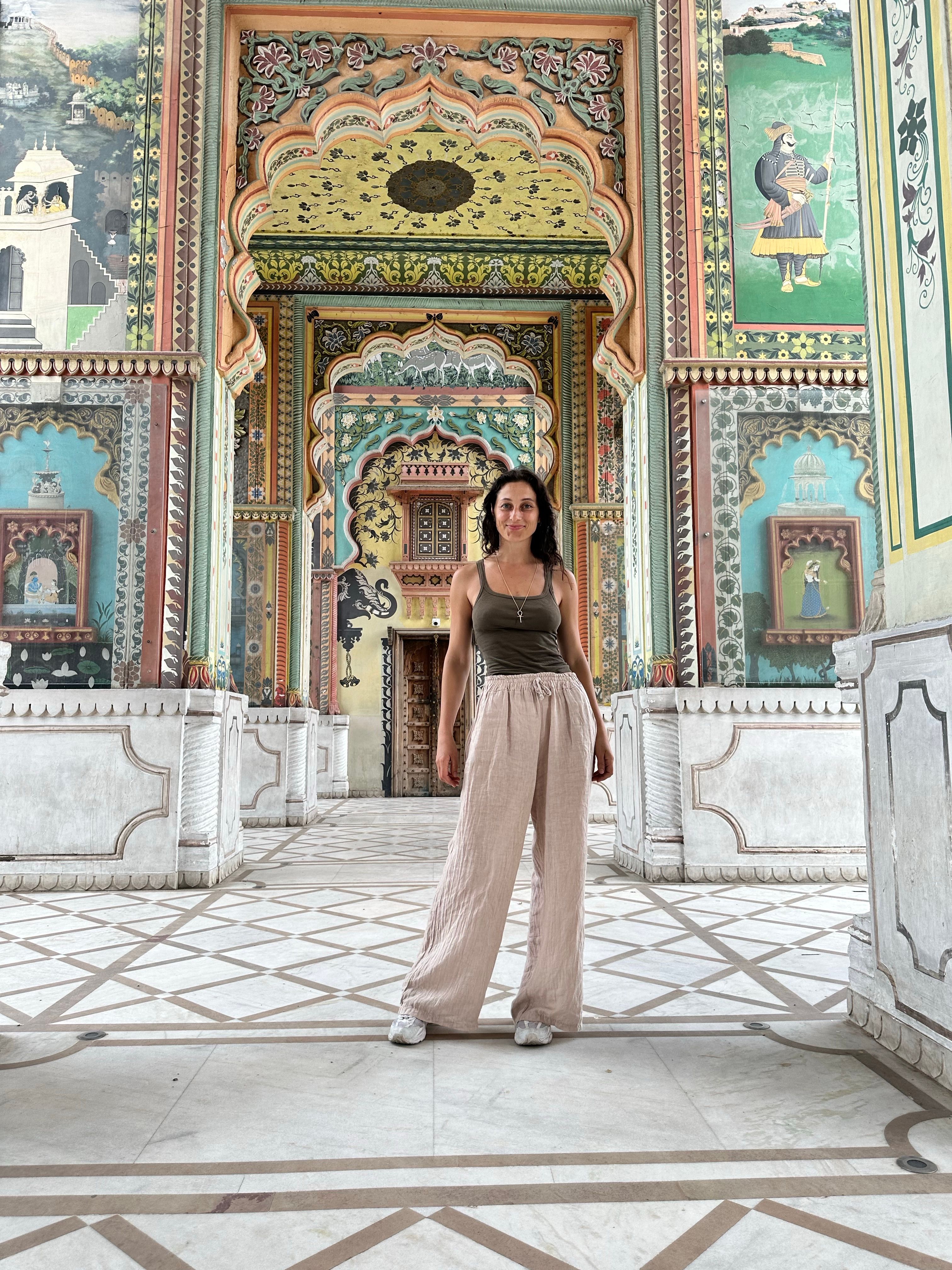 A woman standing in front of a building with ornate walls · Free Stock ...