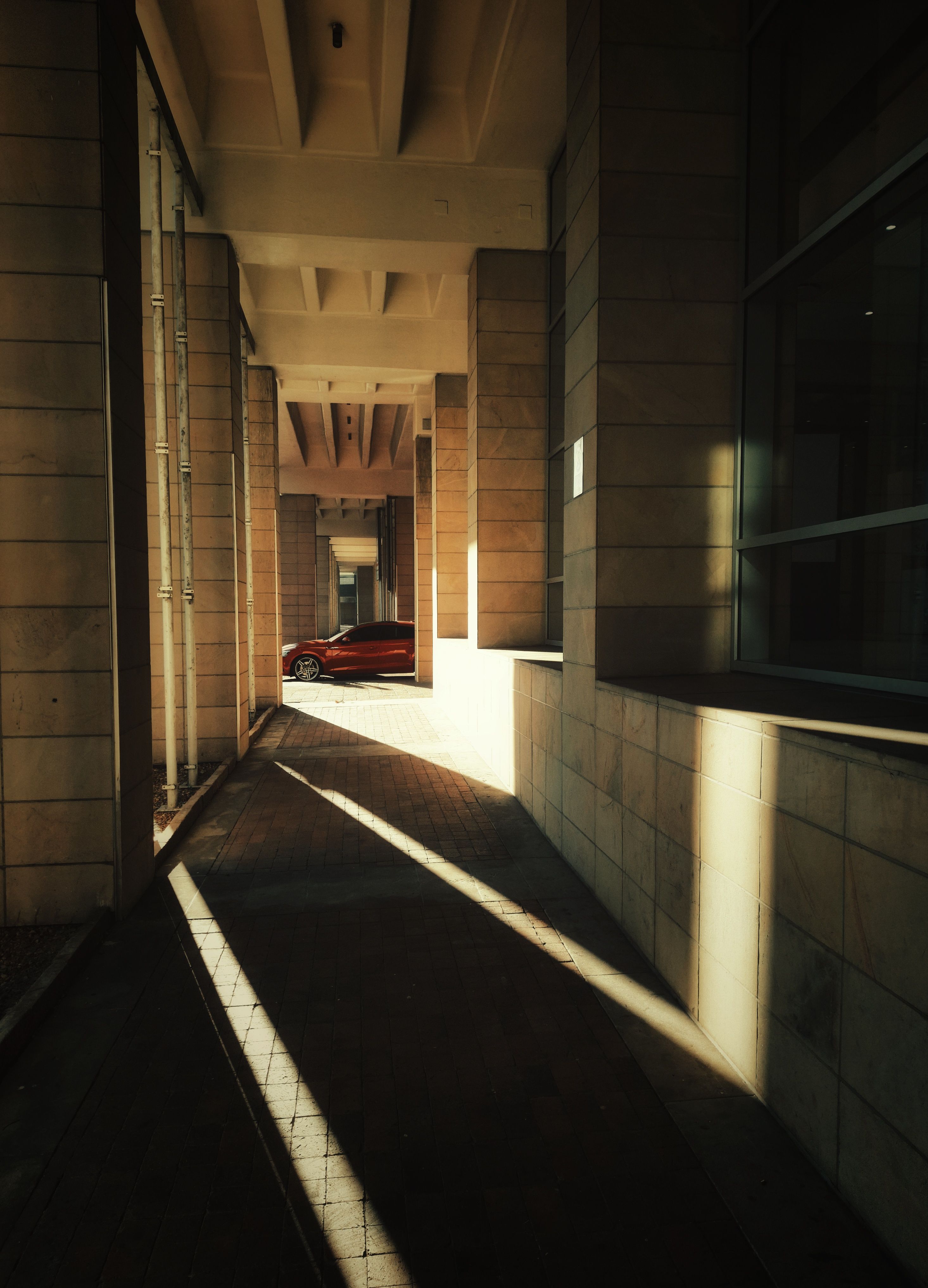 A red car is parked in a hallway · Free Stock Photo